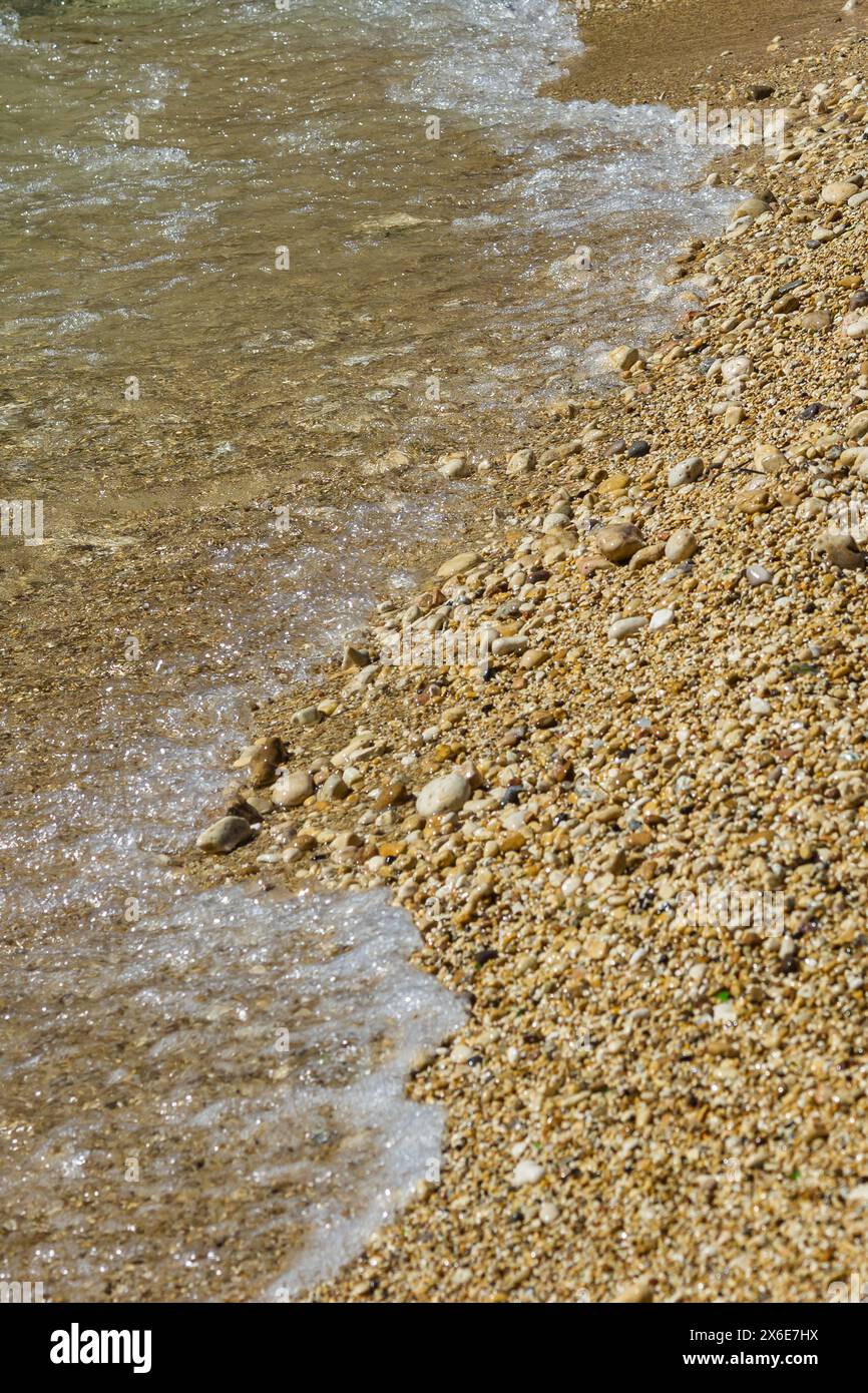 small stones on the beach with some waves of water Stock Photo - Alamy