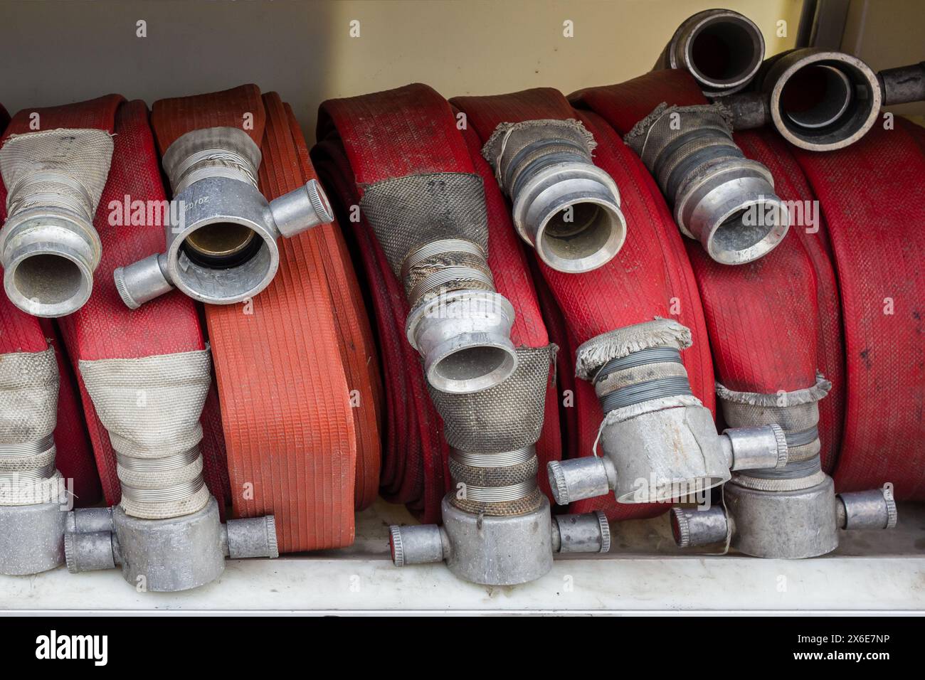 red fire hose and pipes of a fire truck Stock Photo - Alamy