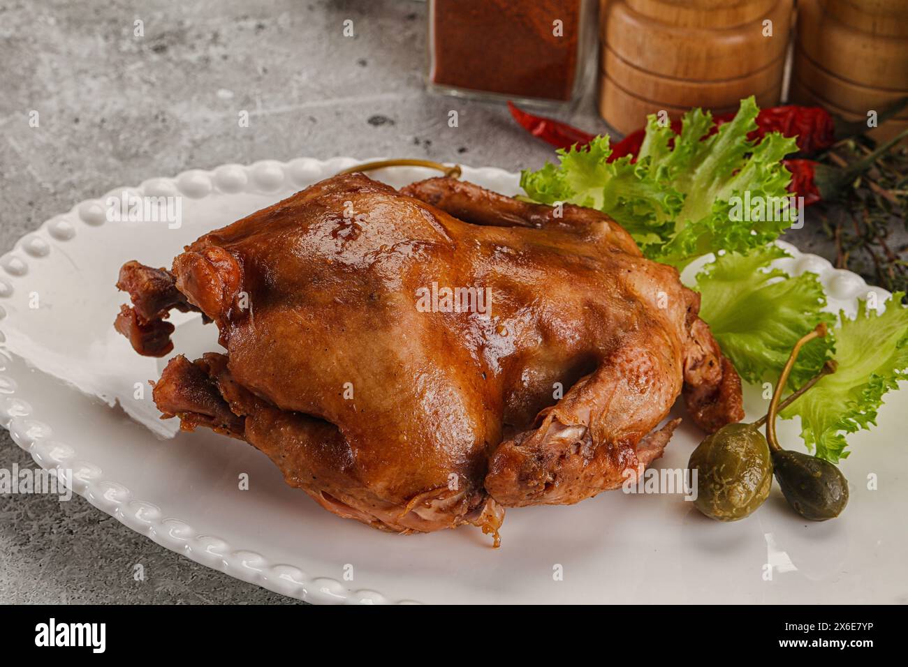 Baked whole small chicken with spices Stock Photo - Alamy