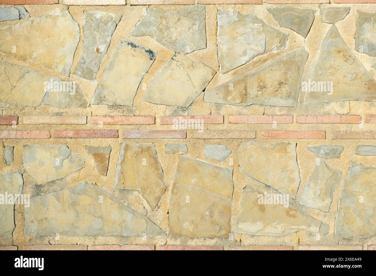 Masonry wall of natural brown stones with irregular pattern texture ...