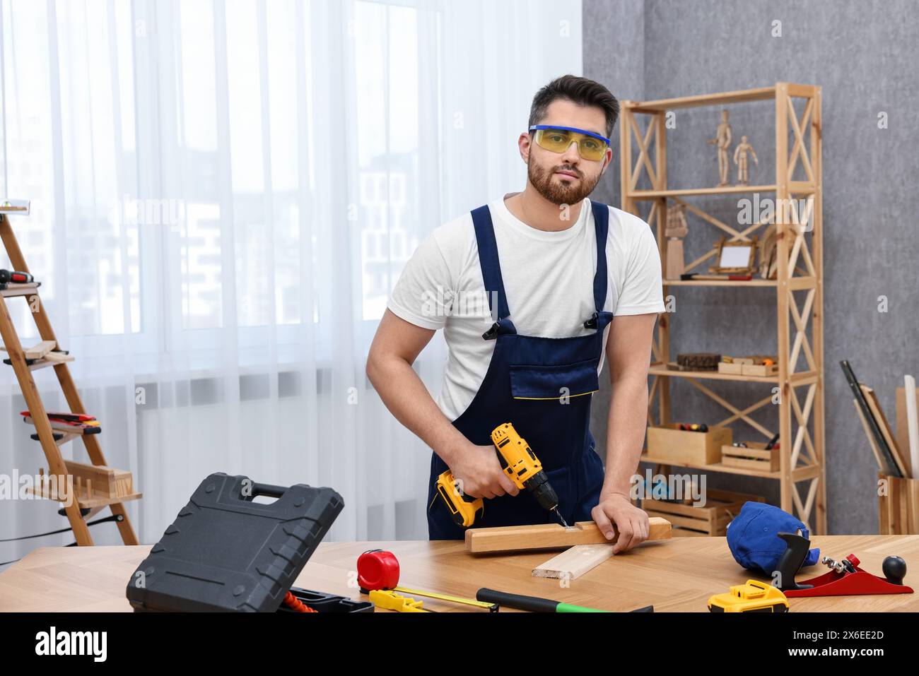 Young worker using drill hi-res stock photography and images - Alamy