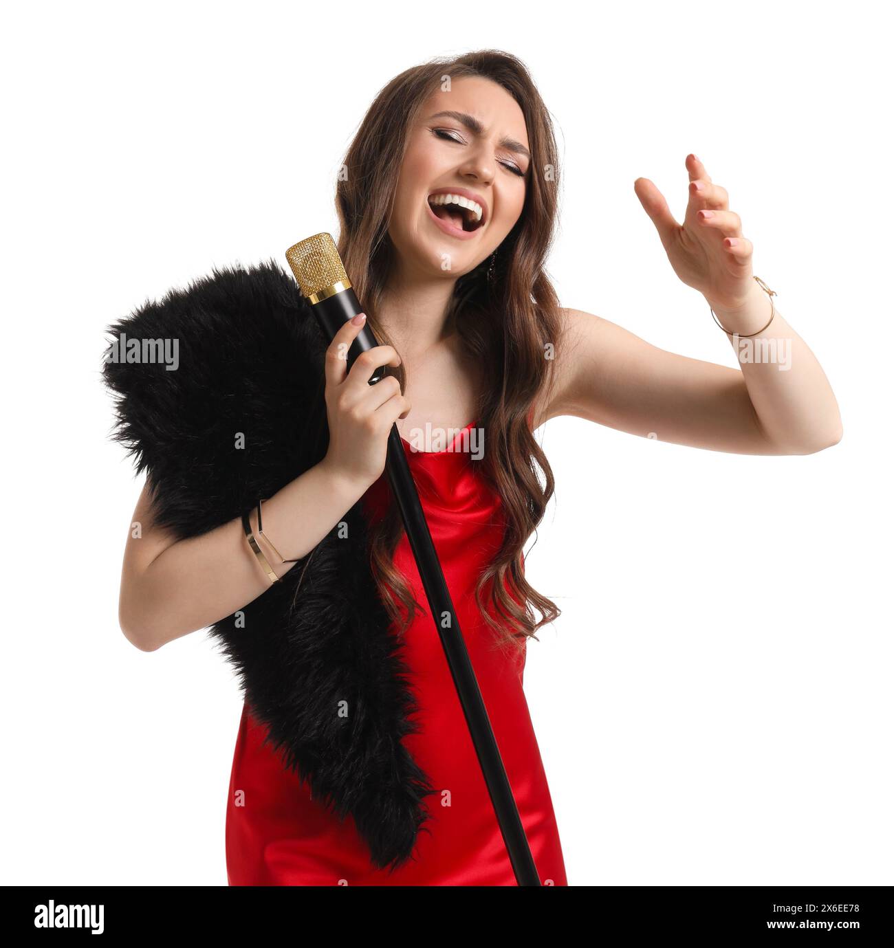 Beautiful young woman in stylish red dress with microphone singing on ...