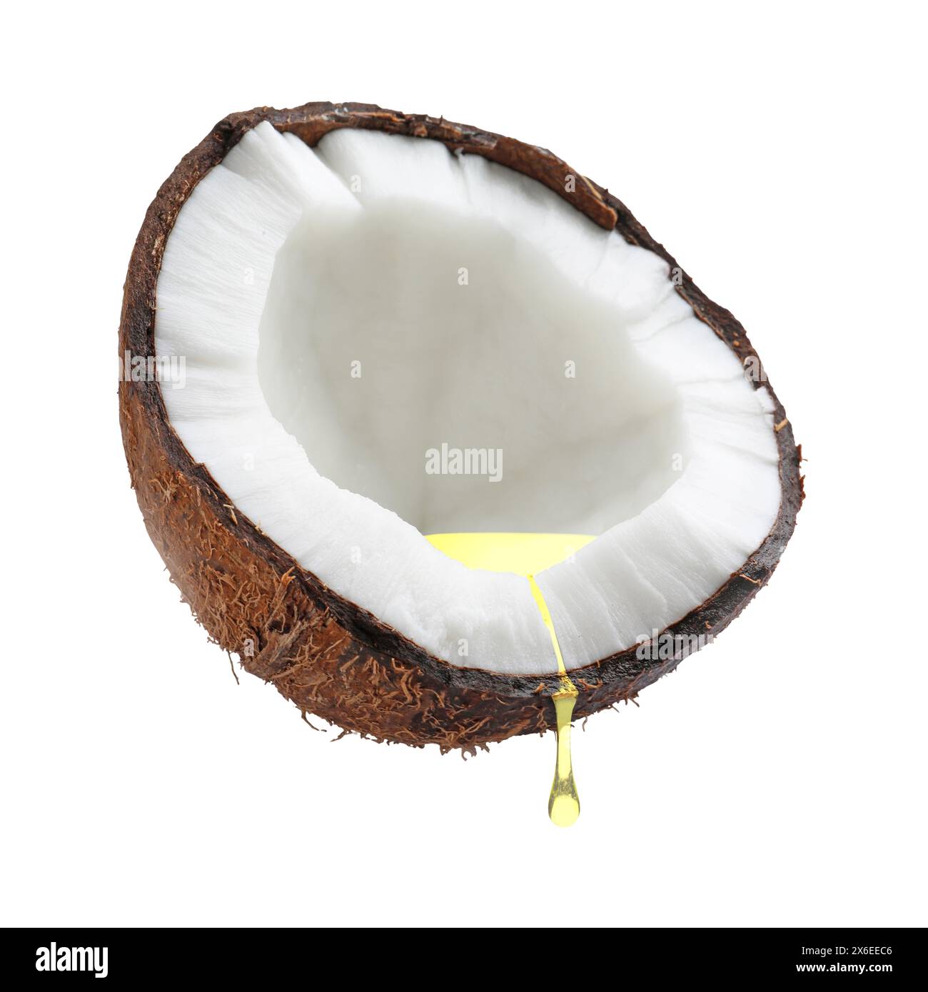 Coconut with dripping oil isolated on white Stock Photo - Alamy