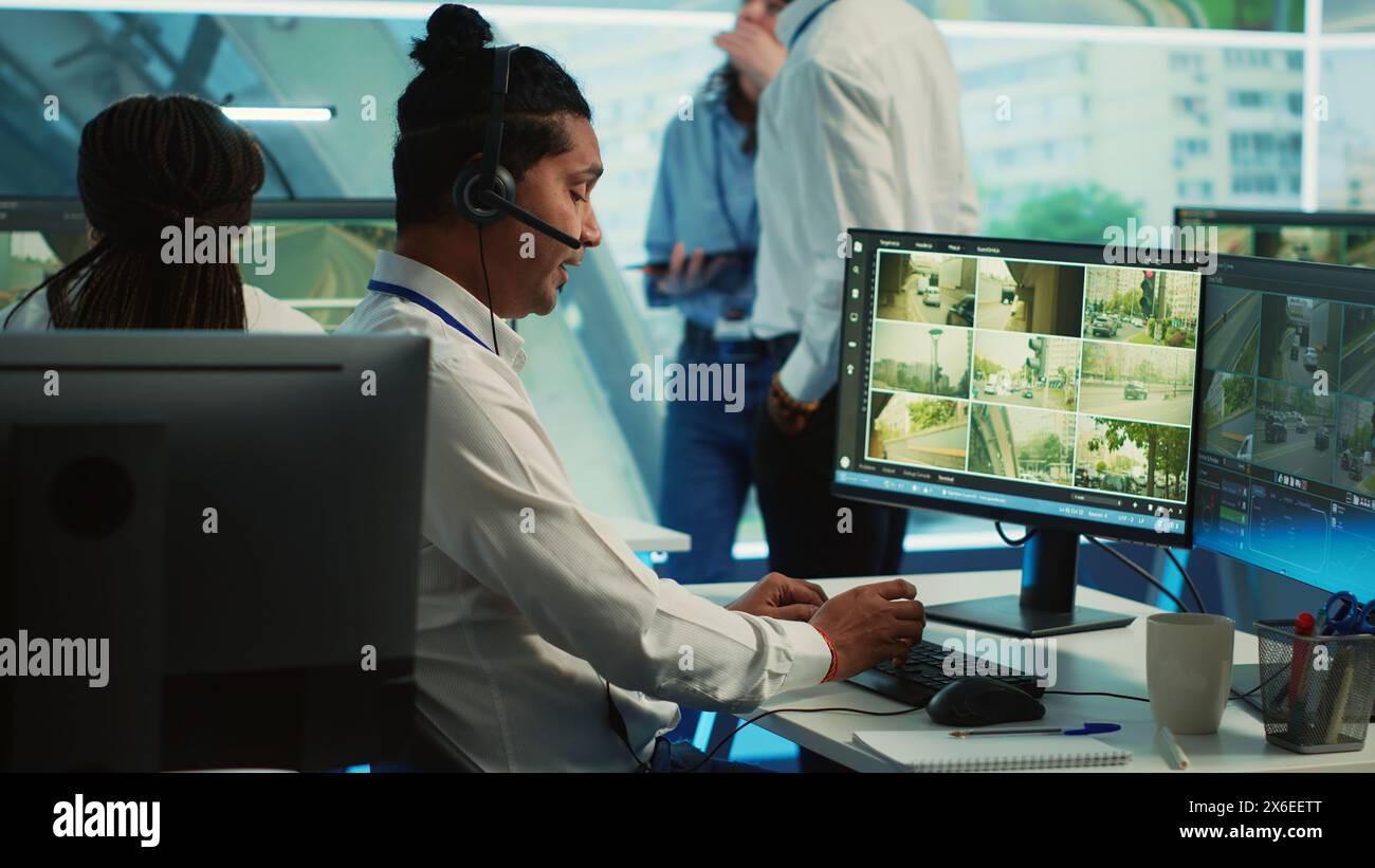Indian Employee Communicating Satellite Map Directions In Observation Room Monitoring Traffic