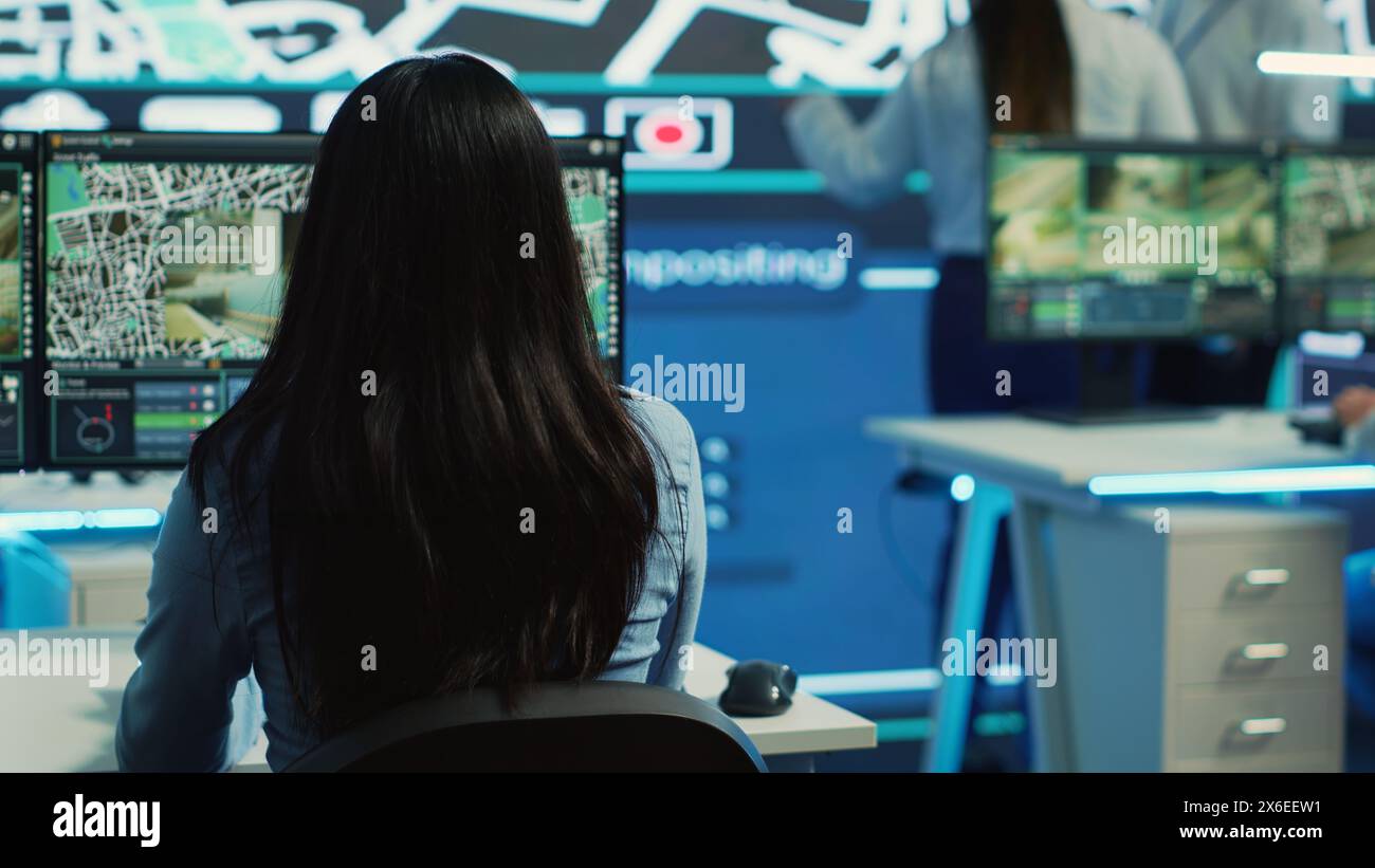 Diverse team of employees monitoring delivery trucks routes around the ...