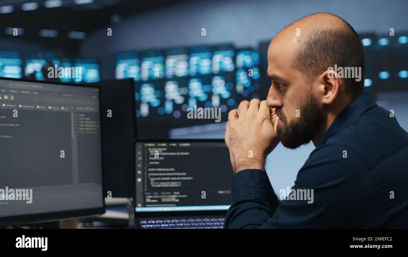 Computer scientist working in network security data center facility, ensuring optimal ...