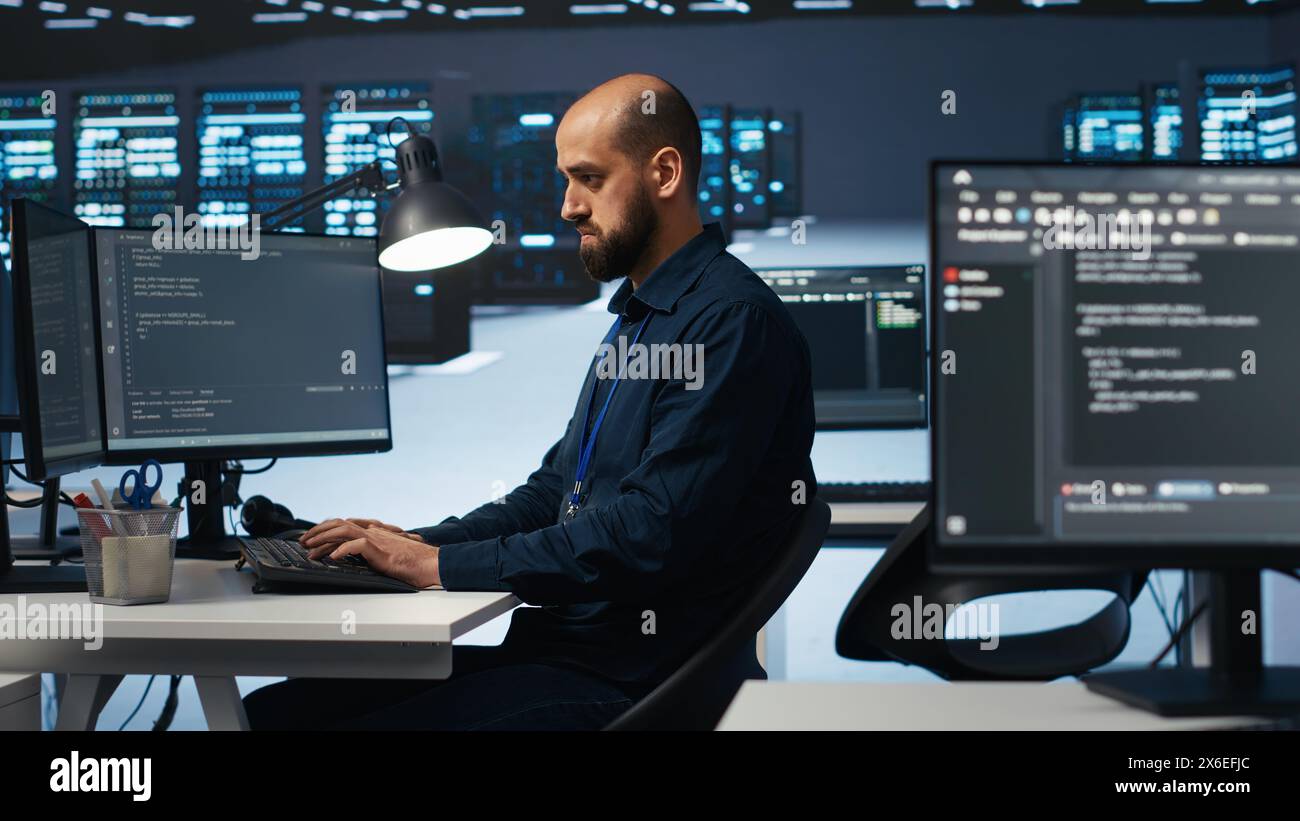 Computer scientist programming in high tech facility with server rows providing computing ...