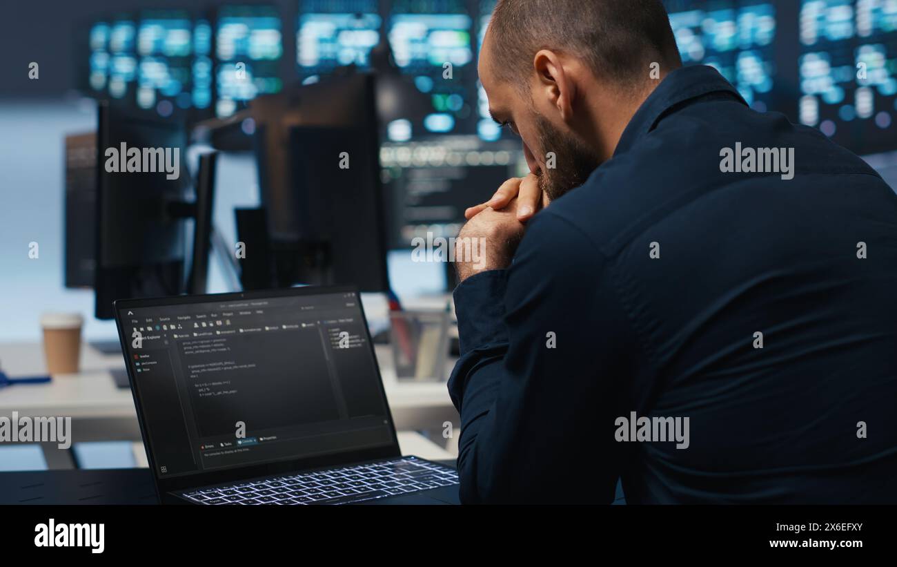 Computer Scientist Overseeing Data Center Servers Typing Code On Laptop Troubleshooting Rigs