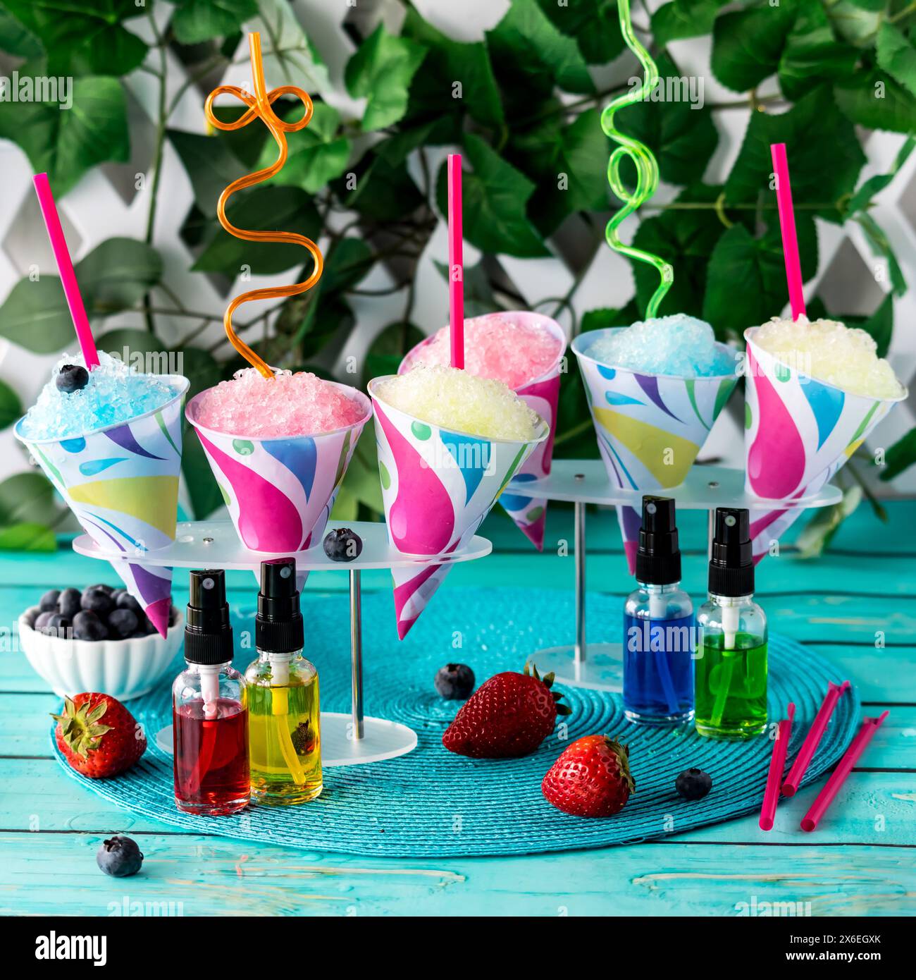Fruit flavoured shaved ice snow cones with flavour syrups in front ...