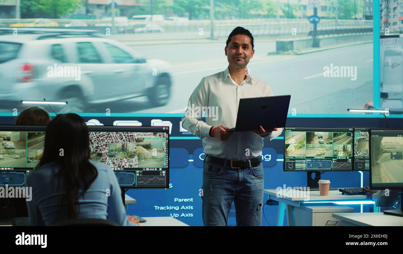 Indian manager supervising his employees team in observation room ...