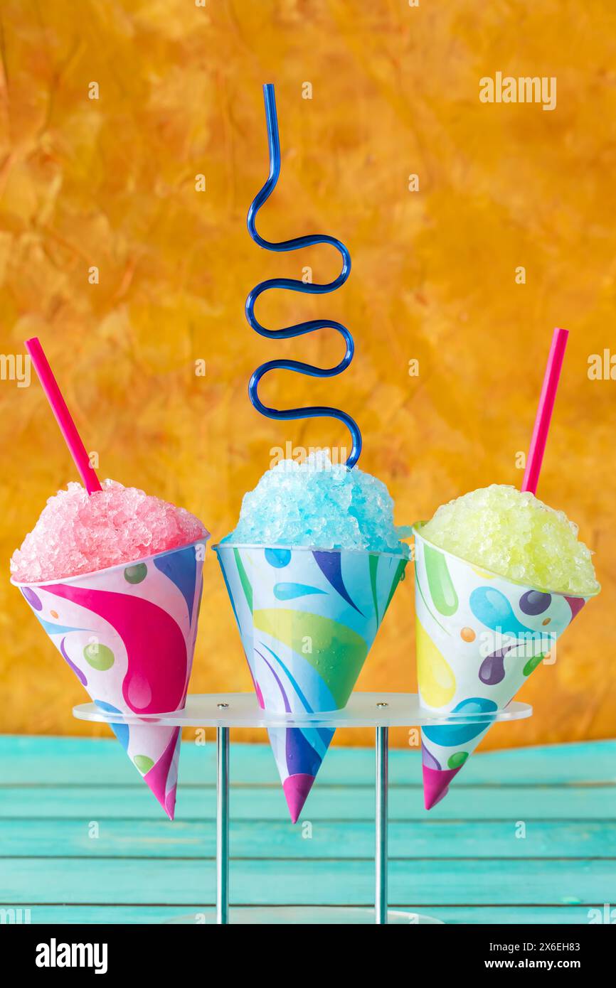 Colourful snow cones in a stand against an orange background Stock ...
