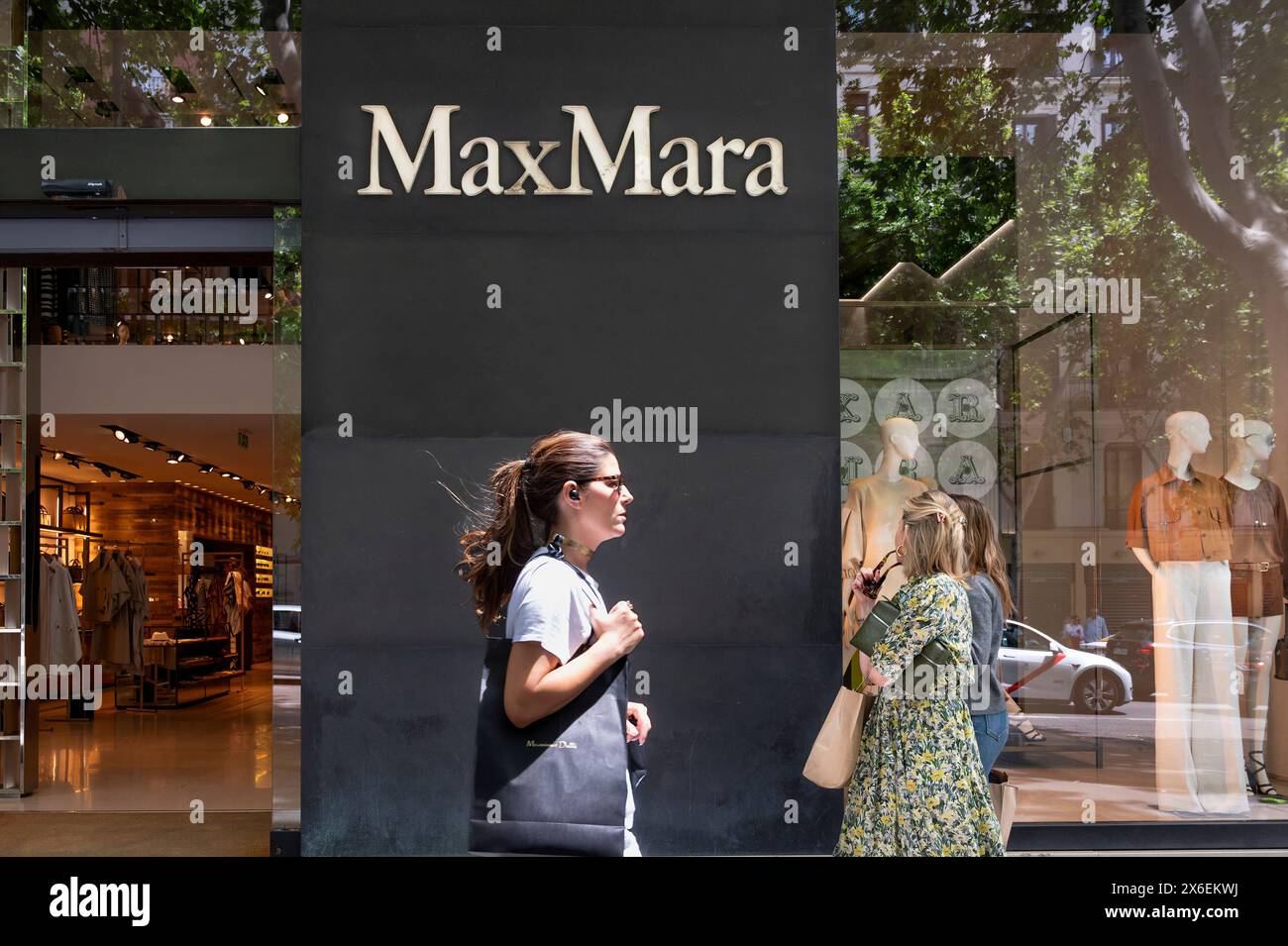 Pedestrians walk past the Italian fashion brand Max Mara (MaxMara) store seen in Spain Stock ...