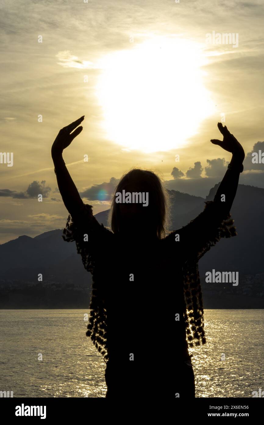 This poignant image captures the silhouette of a beautiful woman, her ...