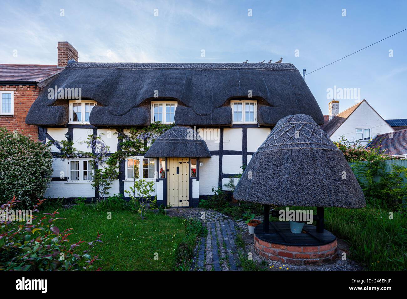 The front of a pretty thatched white timbered cottage in Callow End, a ...