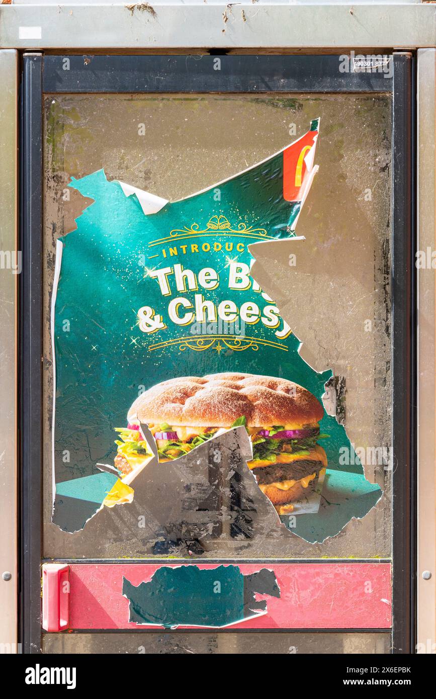 Torn and ripped poster advertising a brand of cheeseburger Stock Photo ...