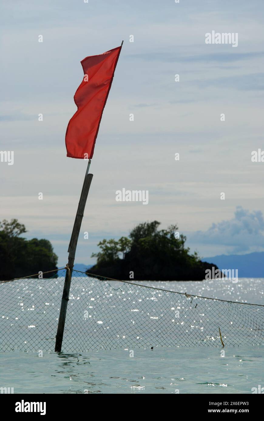 Poles with red flag to indicate position of fishing pots. Piagao ...
