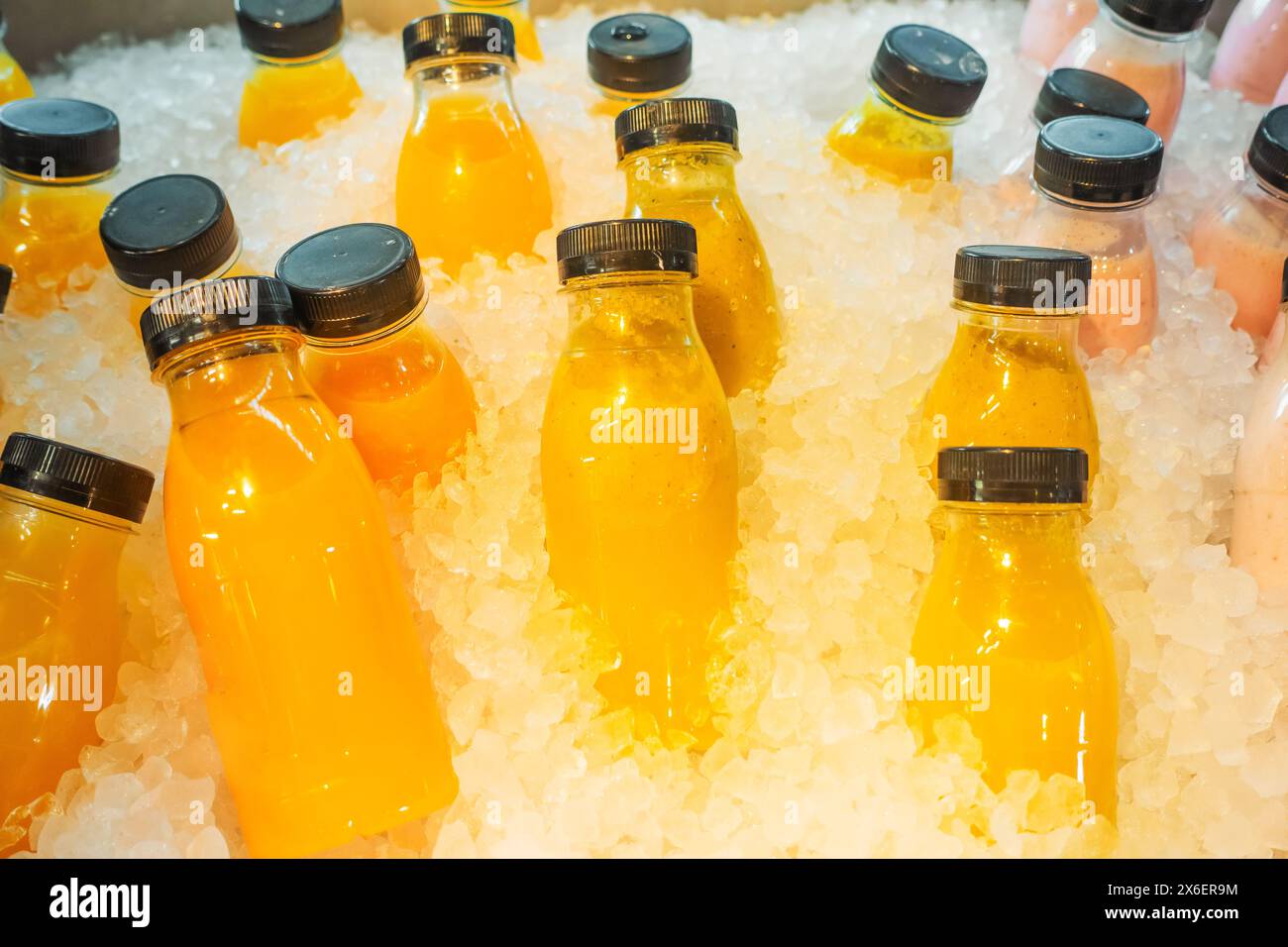 Healthy fresh juice freeze in ice. several plastic bottles of juice ...