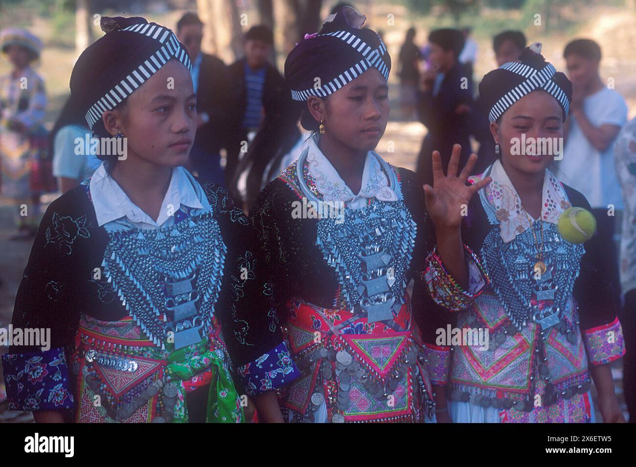 Hmong girls in traditional costume at courting ceremony throwing tennis ...