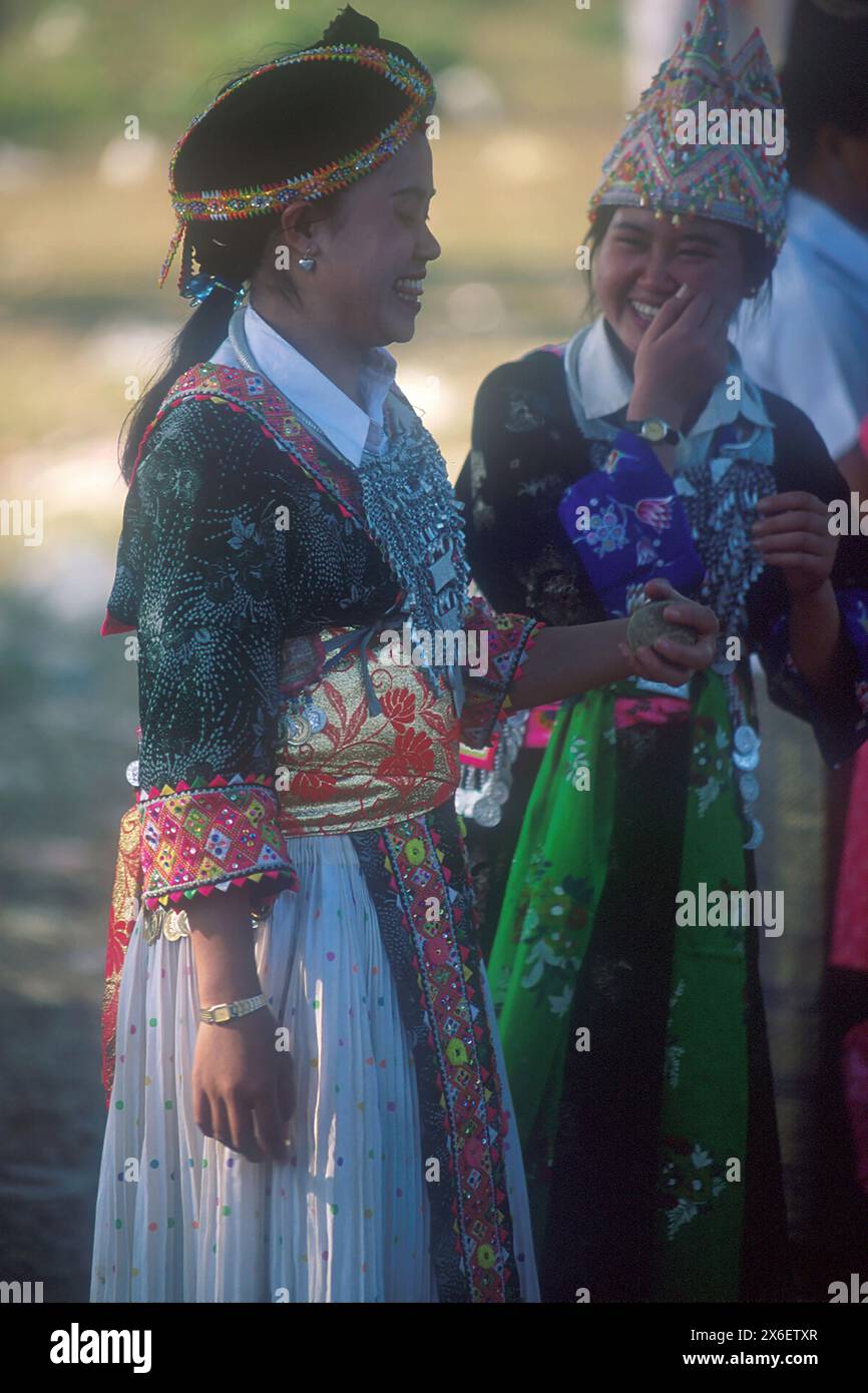 Hmong girls in traditional costume at courting ceremony throwing tennis ...