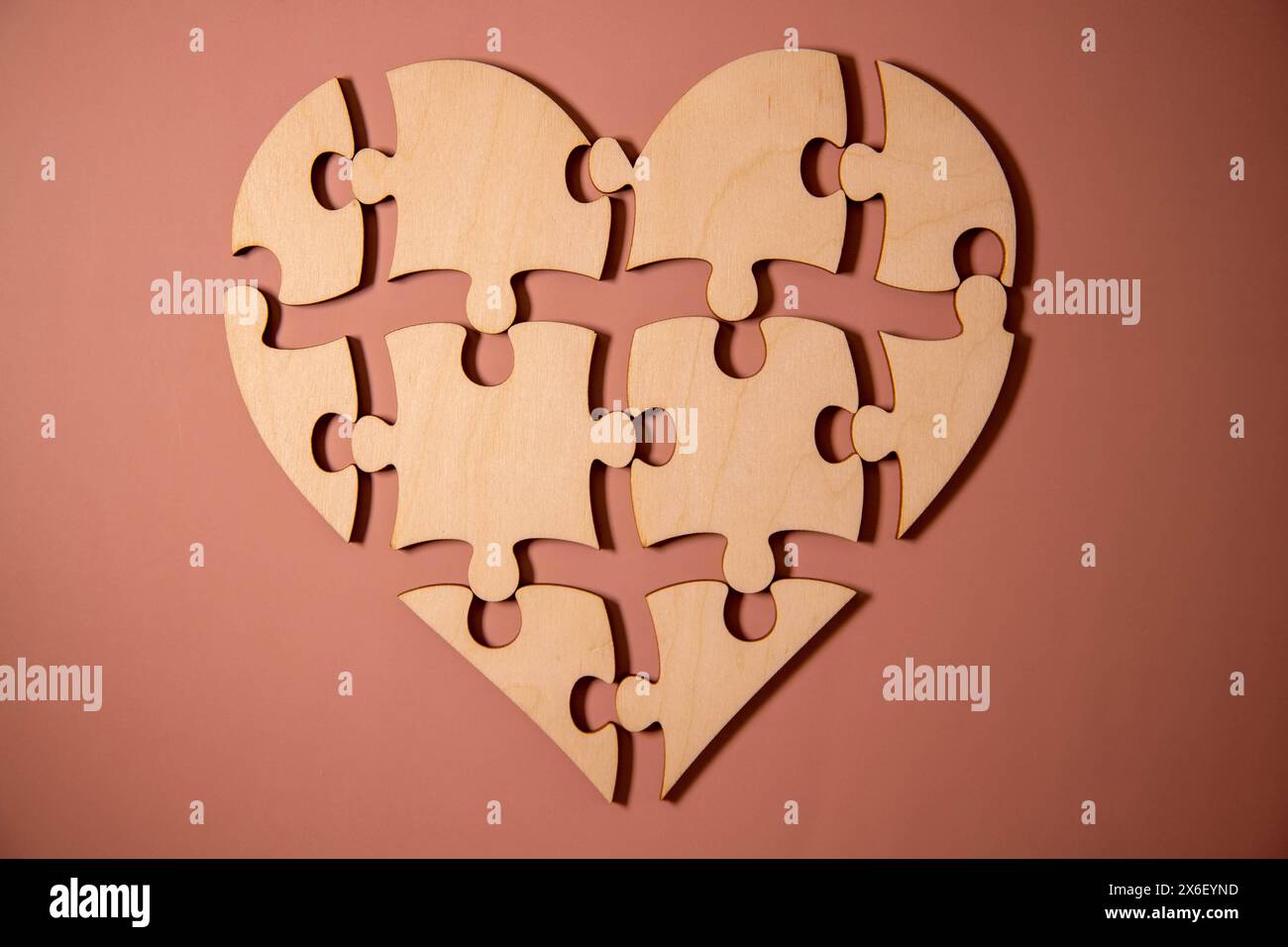 complete wooden heart shape jigsaw puzzle on wood board background . 2 ...