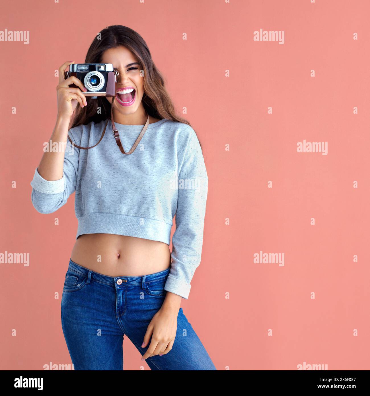 Happy, excited woman and camera with retro and photography in studio ...
