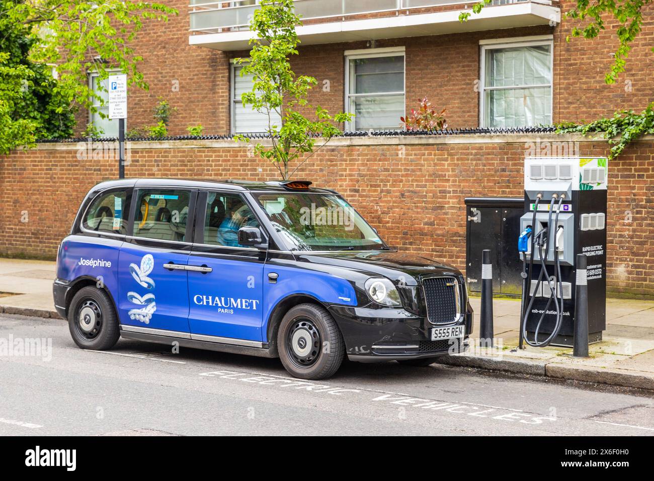 London Taxi at a EV street charging station, London, Sunday, April 28 ...
