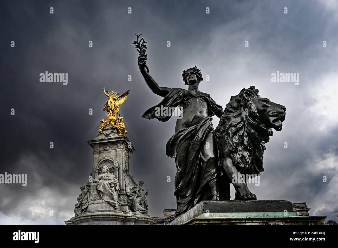 Statue of female figure and lion, Peace, with Winged Victory background ...