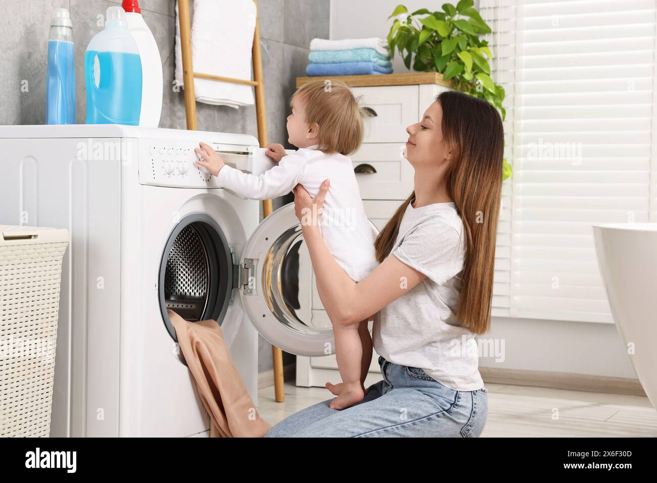Mother and child washing clothes hi-res stock photography and images ...