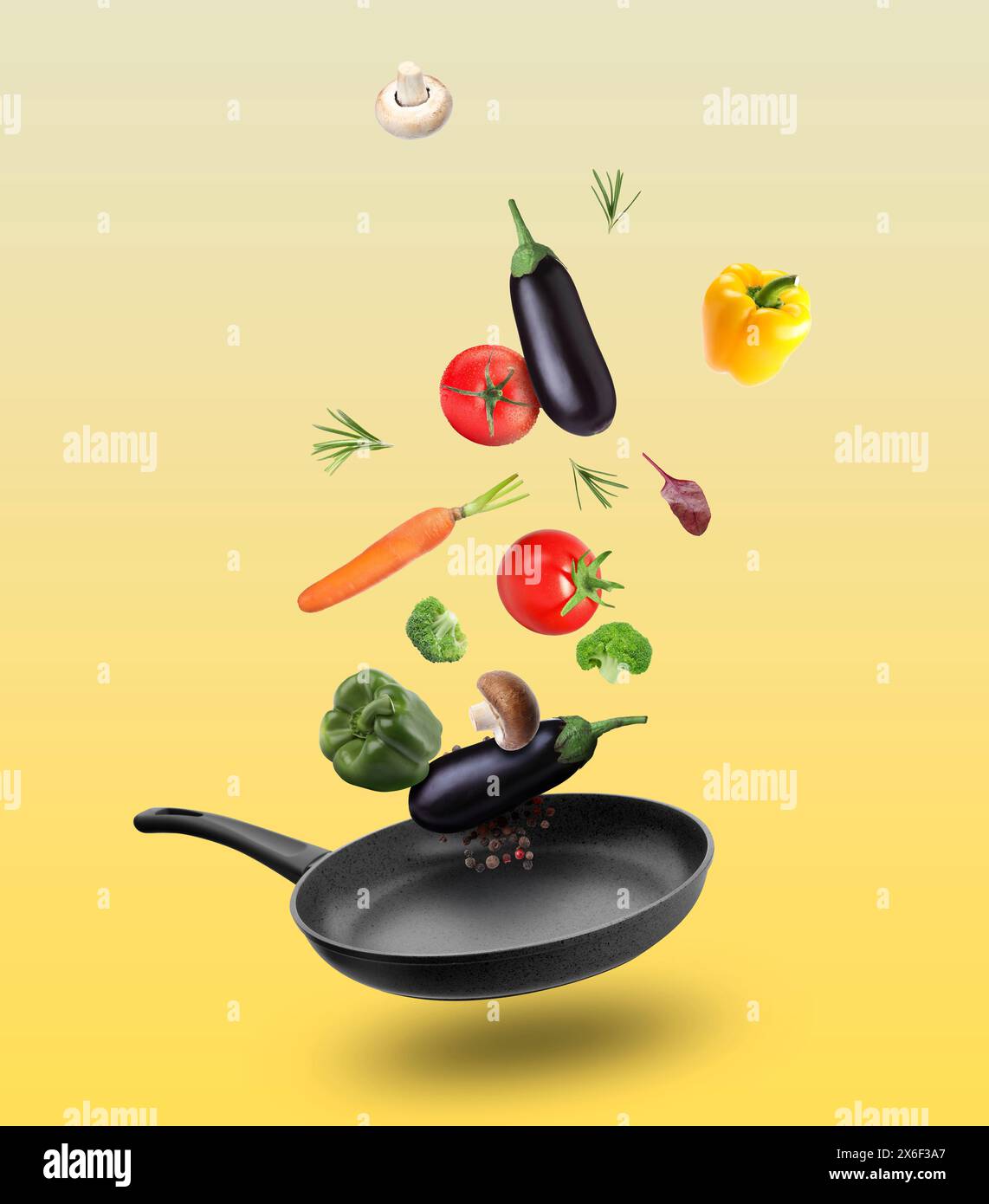 Frying pan and different vegetables in air on yellow gradient ...