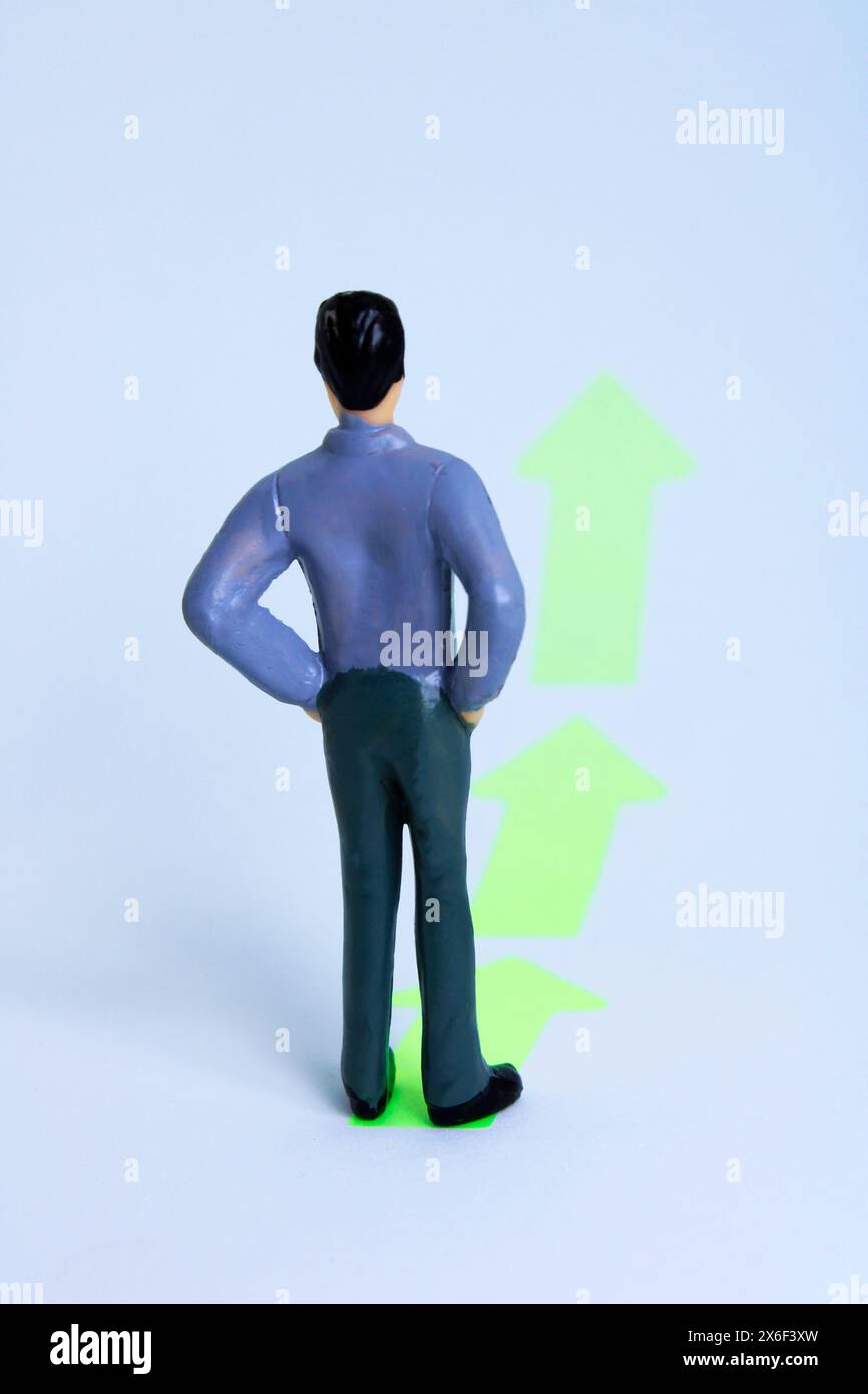 Man in front of arrows indicating an upward direction Stock Photo - Alamy