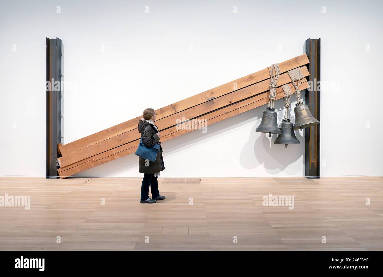 Woman looking at Bells 1993 installation sculpture by Yannis Kounellis ...