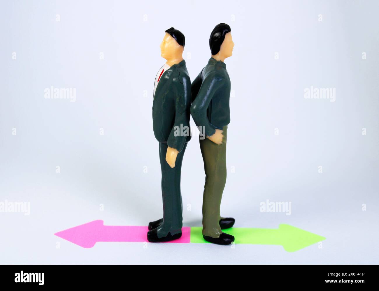 Men on arrows with different colors indicating opposite directions ...