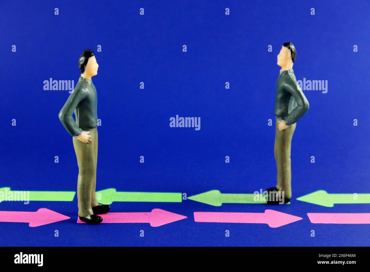 Men taking paths in opposite directions Stock Photo - Alamy