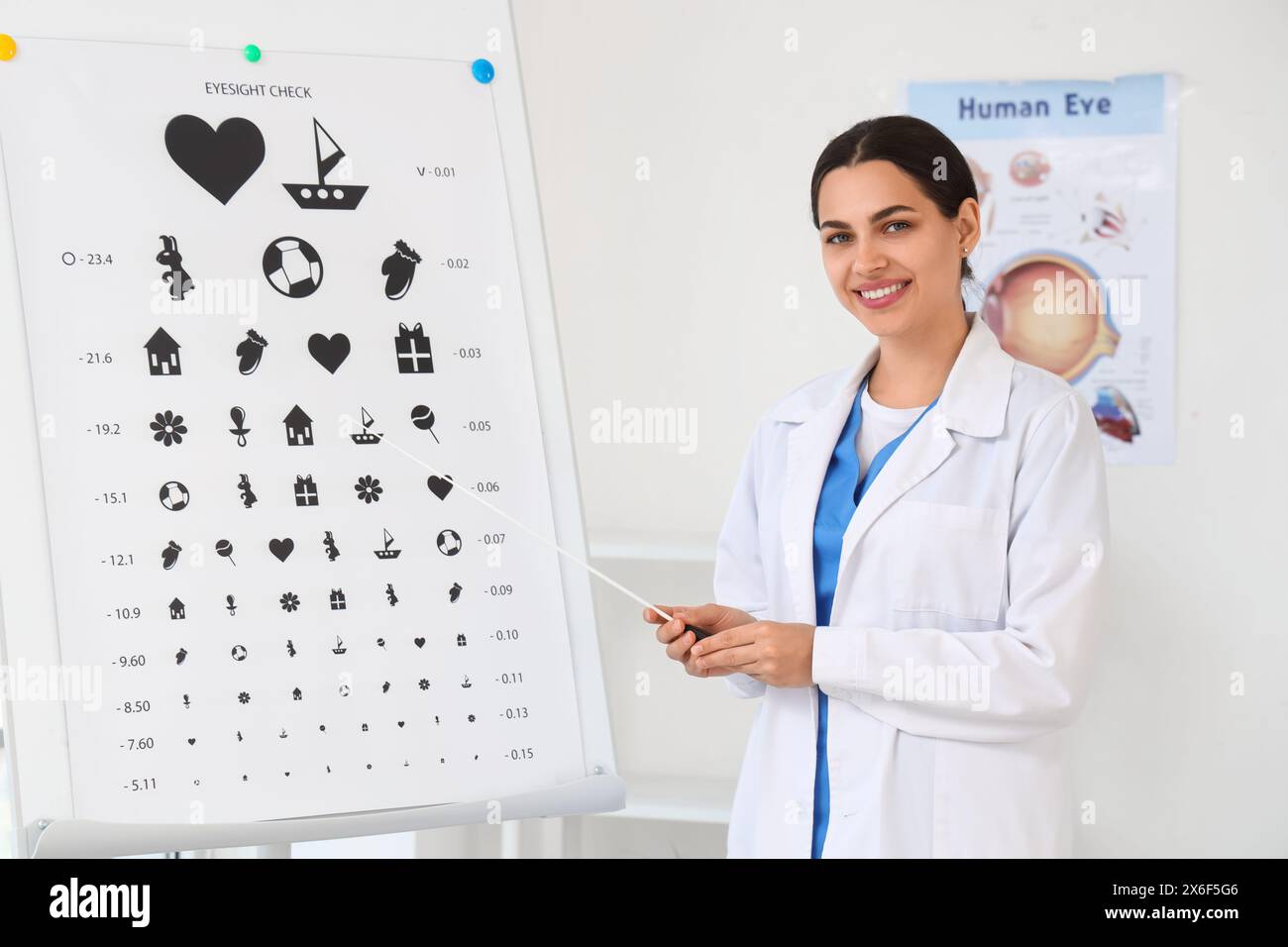 Female ophthalmologist with pointer near eye test chart in clinic Stock ...