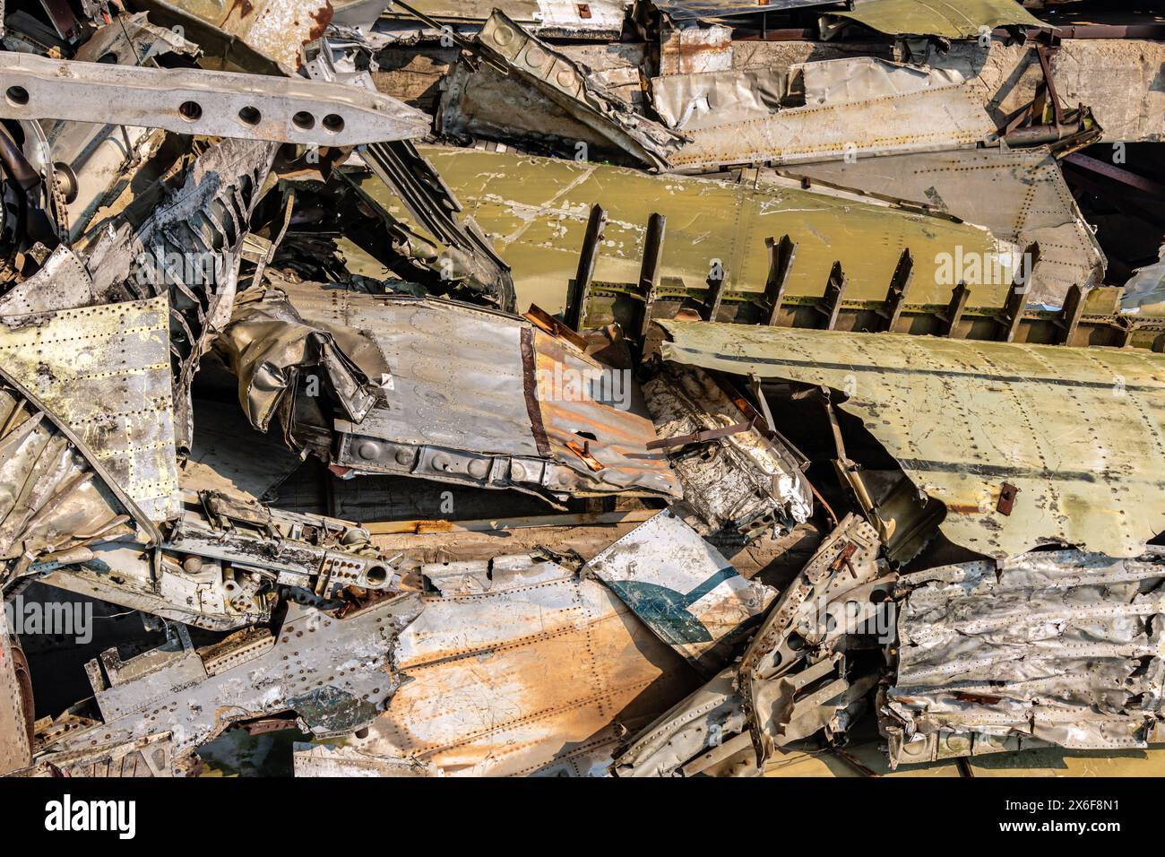 A pile of steel parts from the fuselage and wings of a damaged aircraft ...