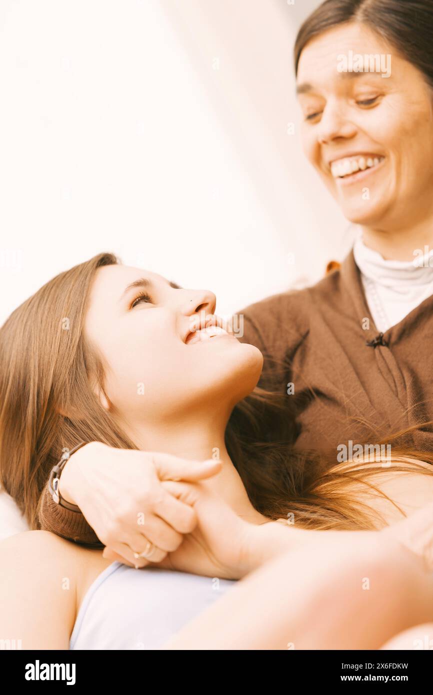 Affectionate embrace shared by daughter and mother, who shows a ...