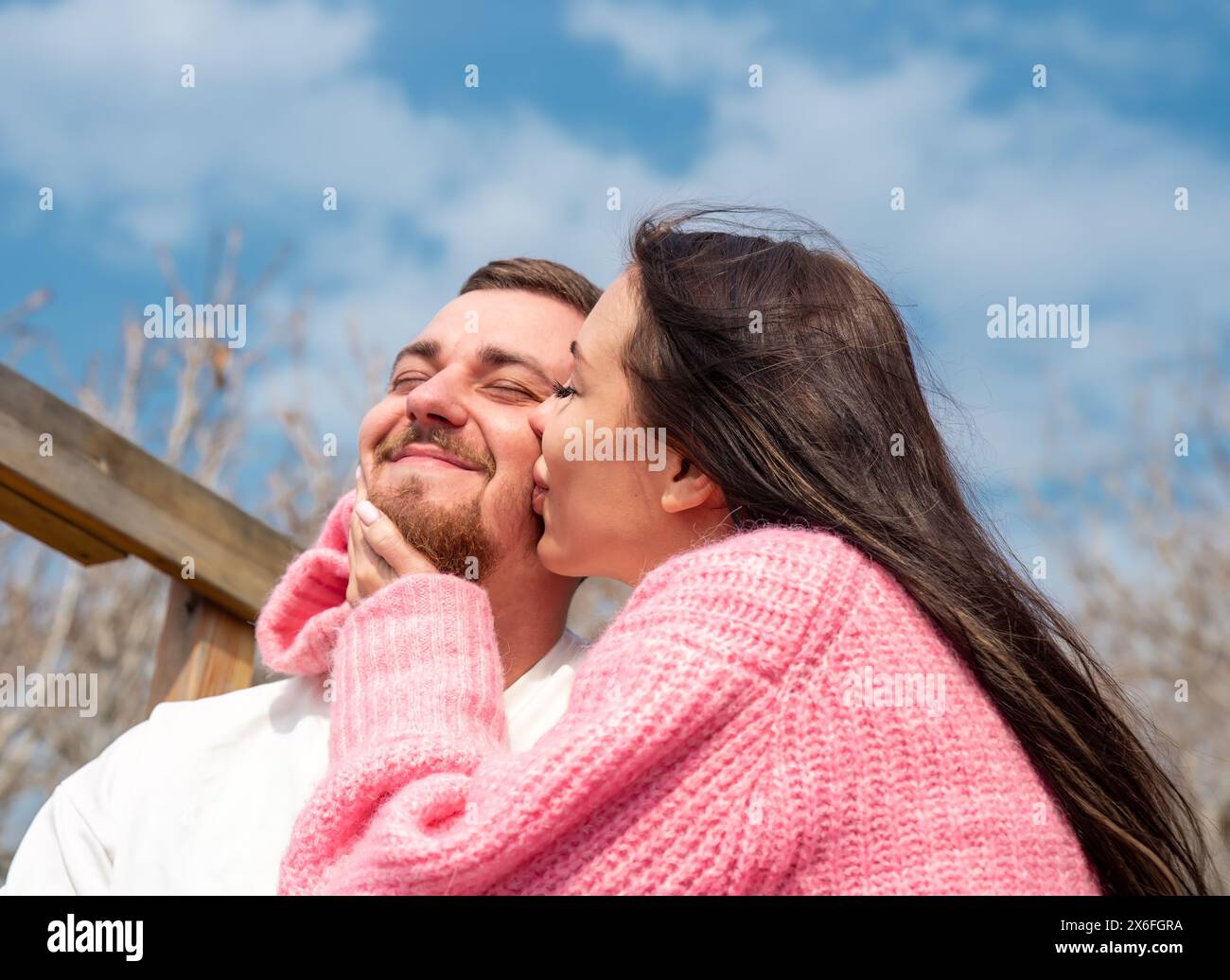 Romantic Portrait Of Young Married Russian Couple Woman Kissing Her