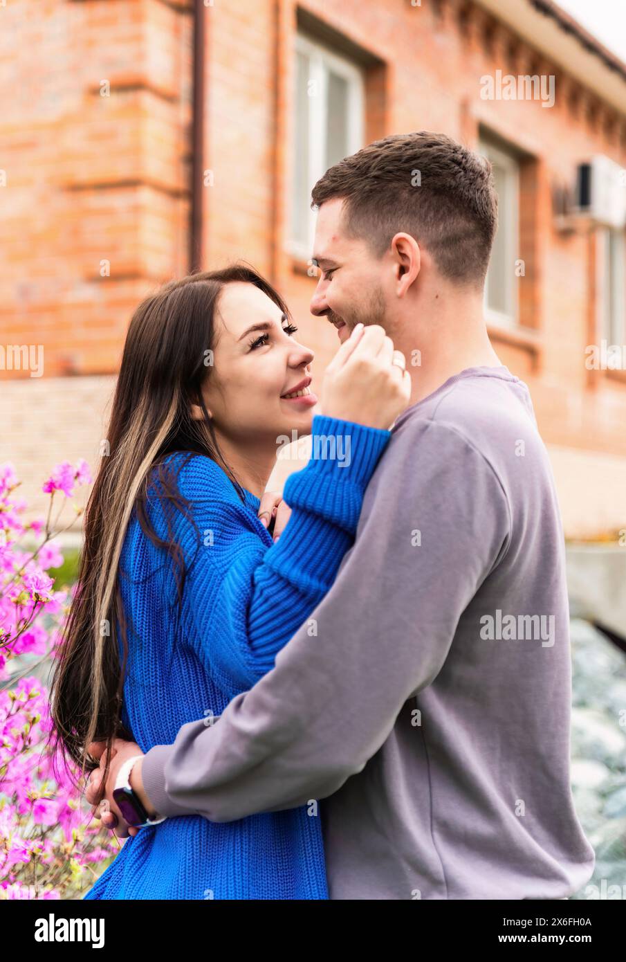 Young woman hugging her boyfriend, they are happy Stock Photo - Alamy