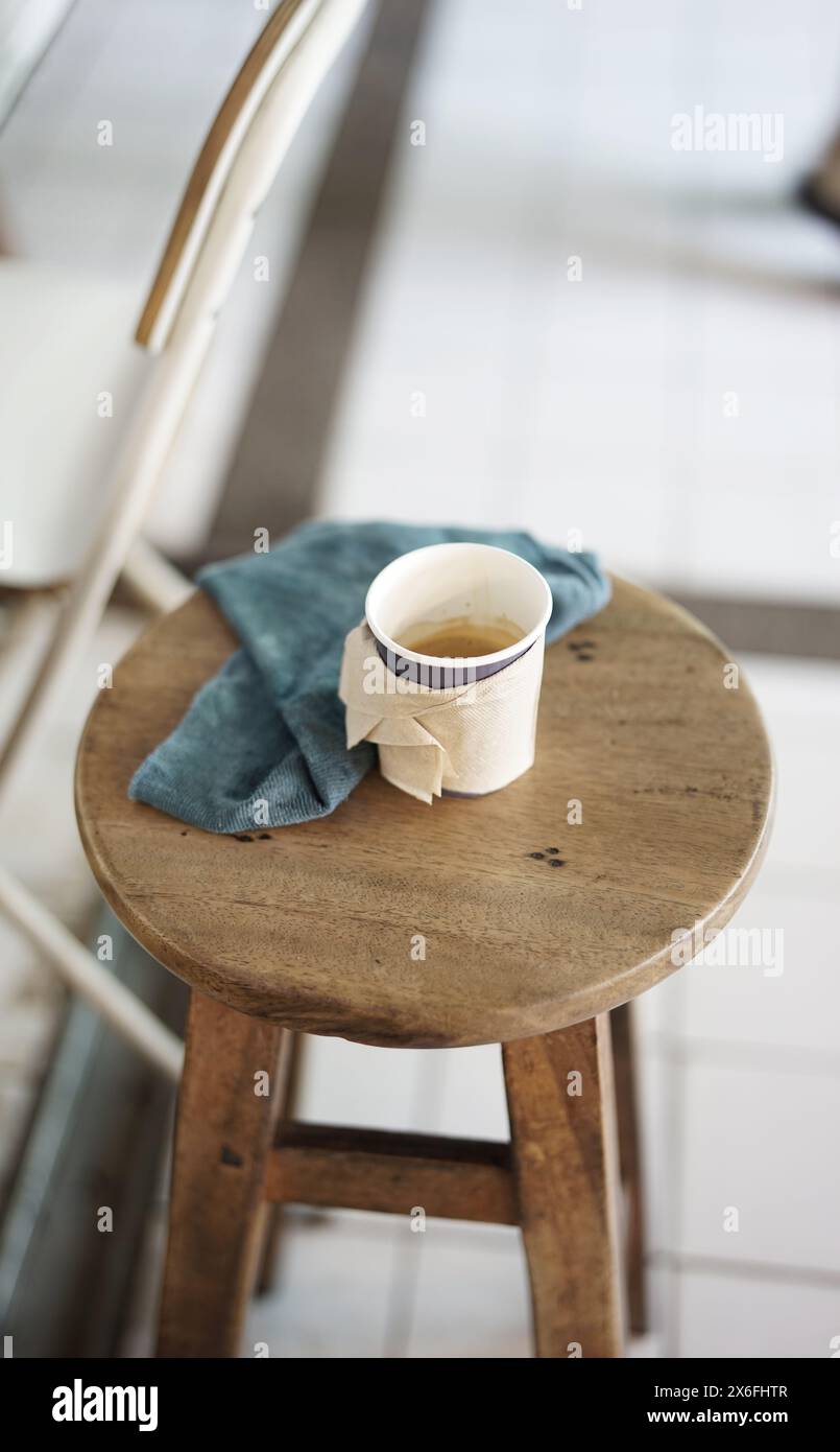 Paper cup of coffee on the wooden stool chair at the outdoor cafe Stock ...