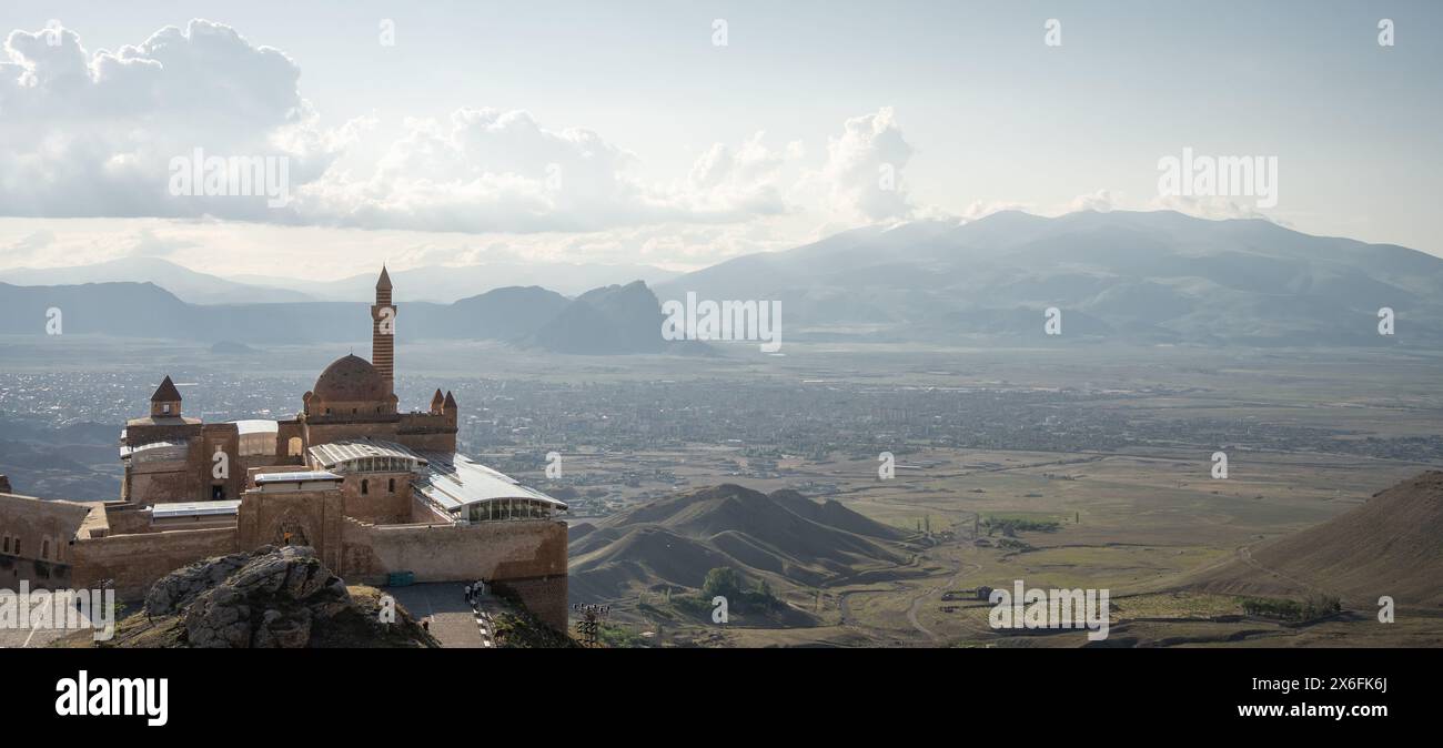 Historical Arabian palace with minarets overlooking city in the valley ...