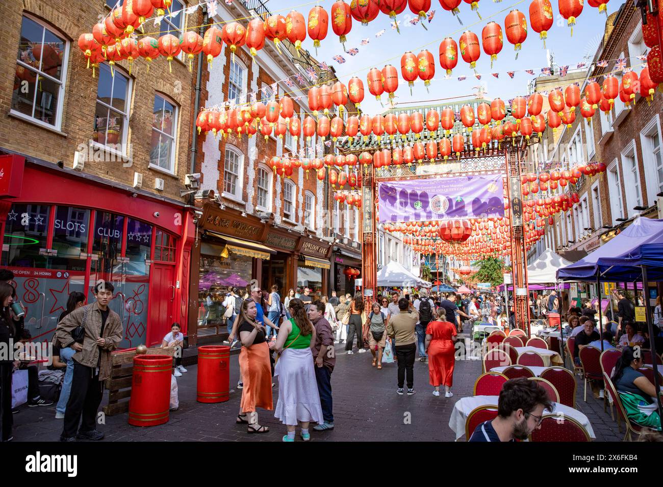 Wardour street Soho London, chinatown red lanterns hang in the street with banners supporting ...