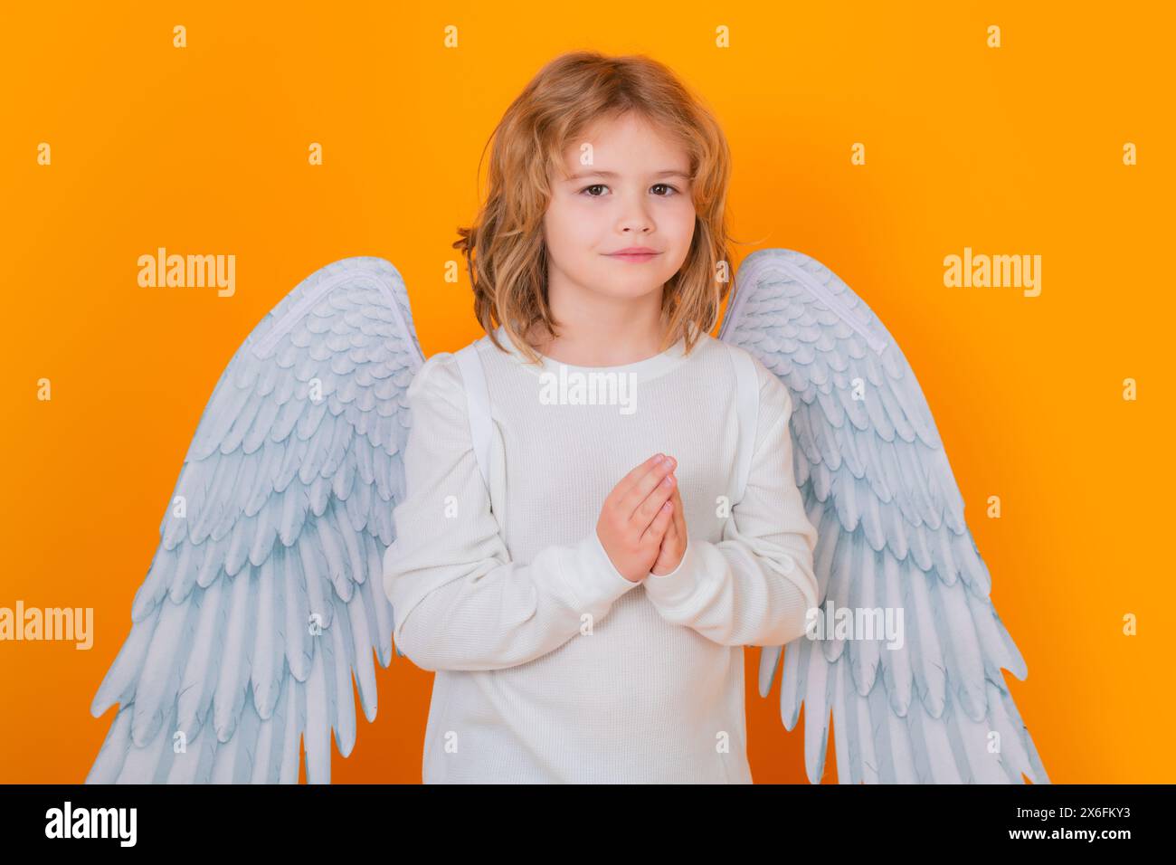 Angel prayer kids. Portrait of cute kid with angel wings with prayer ...