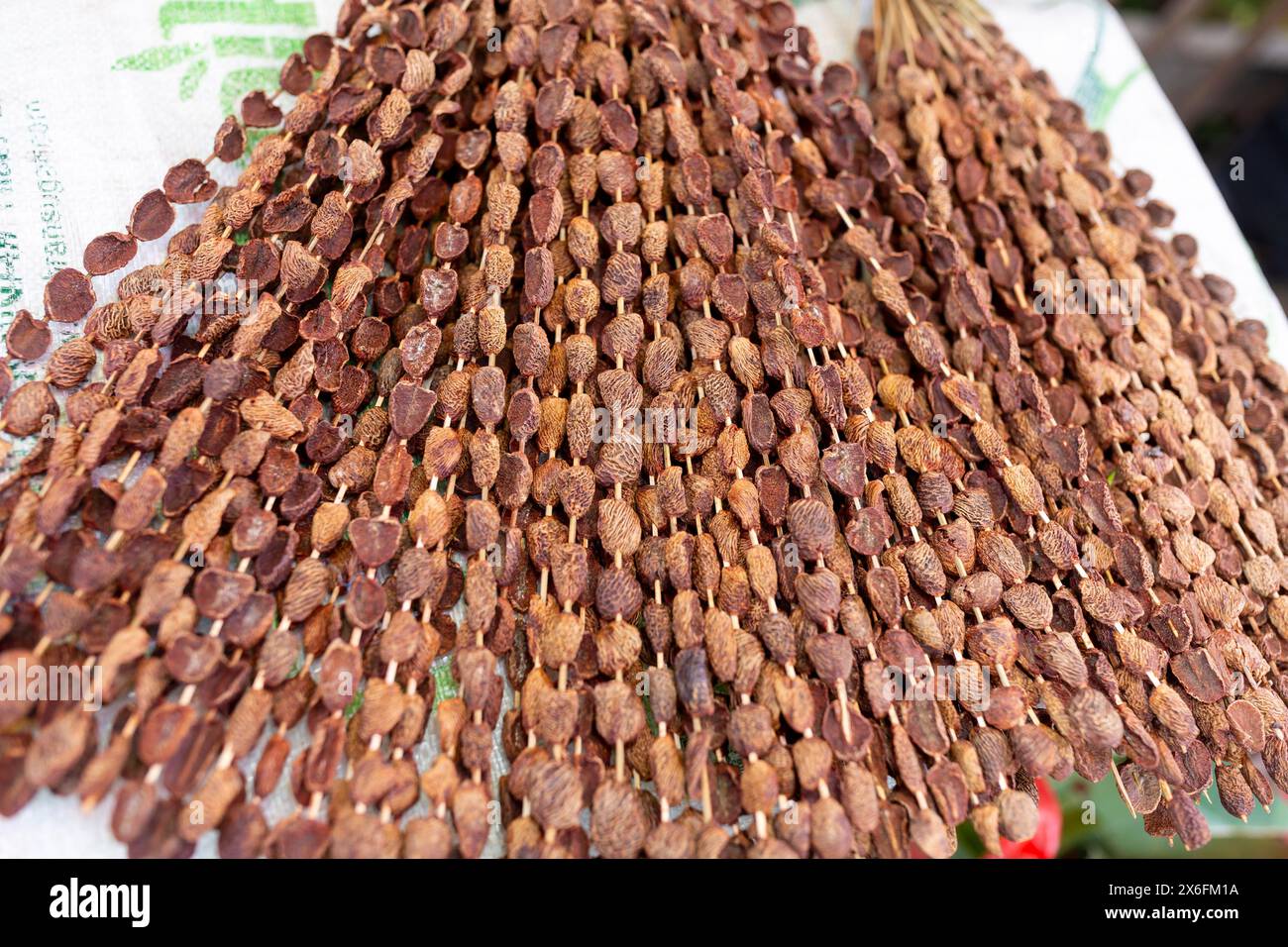 Sun dried betel nut on a string for sale at Mercado Taibesi, Dili ...