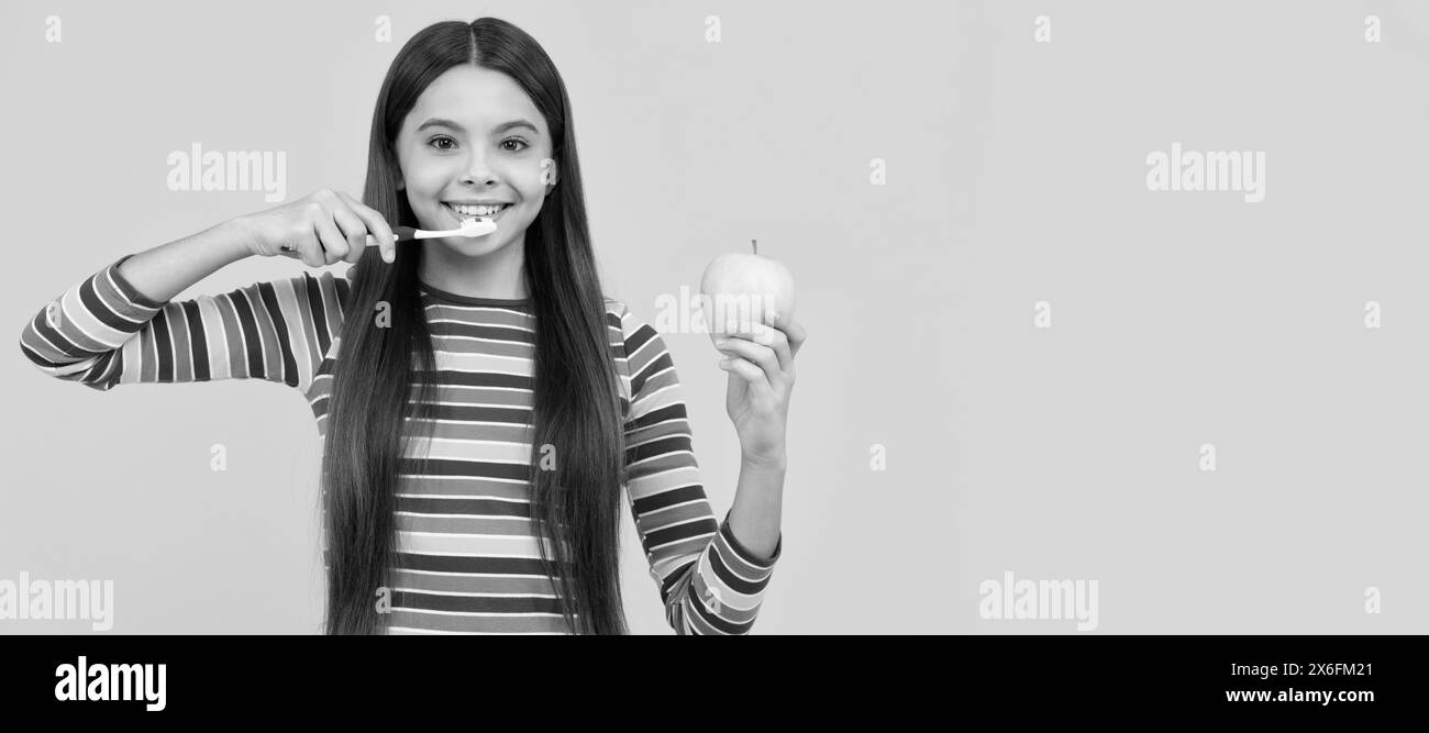 Happy girl child brush teeth with toothbrush holding apple yellow ...