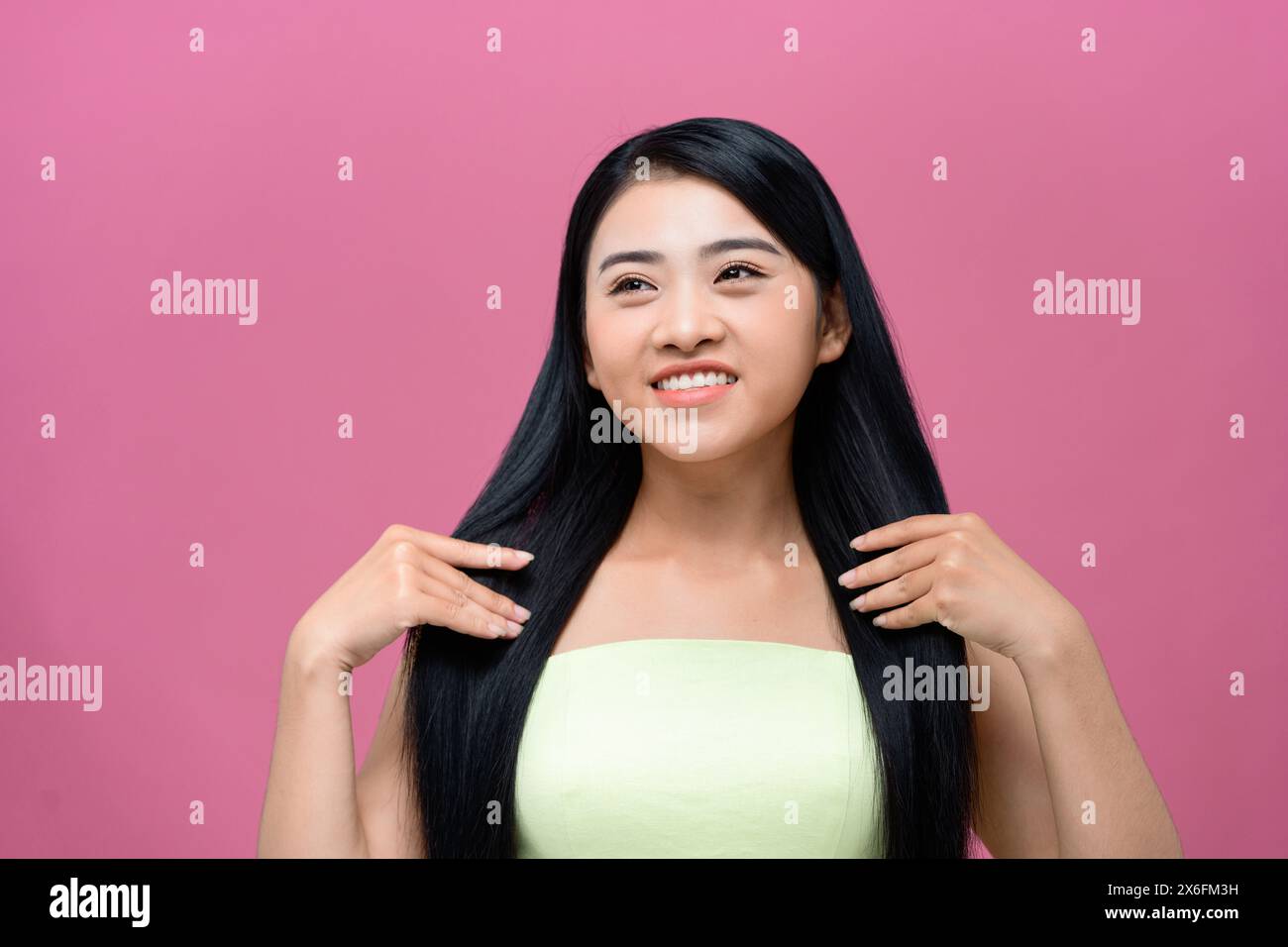 Charming cute woman is standing and looking away while enjoying of the ...