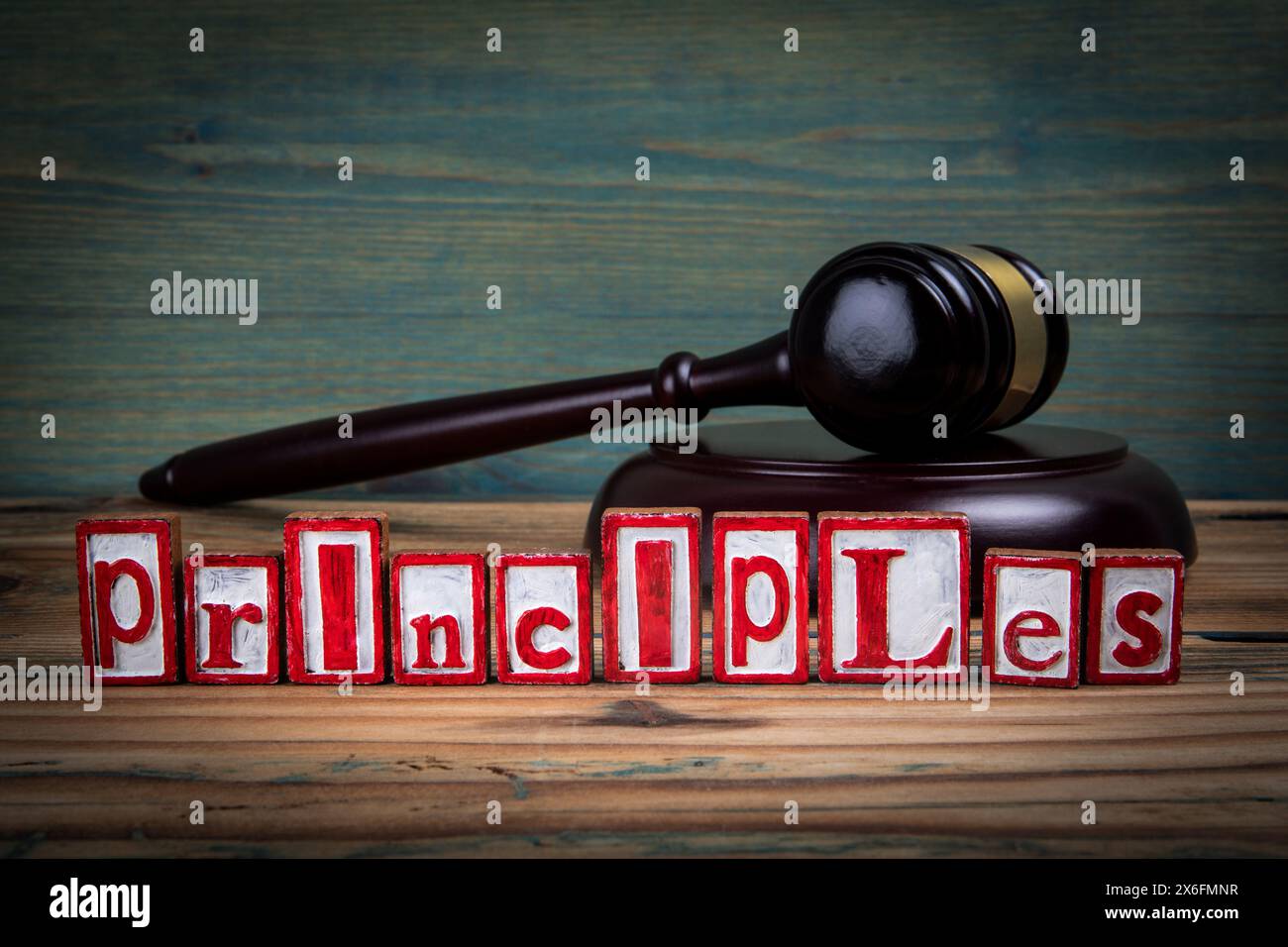 PRINCIPLES. Red alphabet letters and judge's gavel on wooden background ...