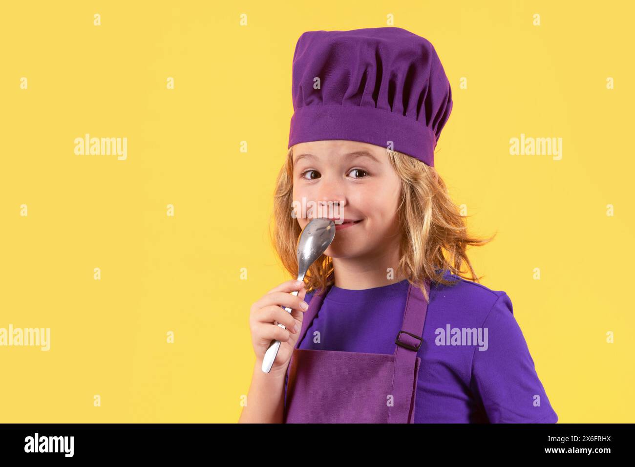 Funny kid chef cook with spoon, studio portrait. Excited chef cook ...