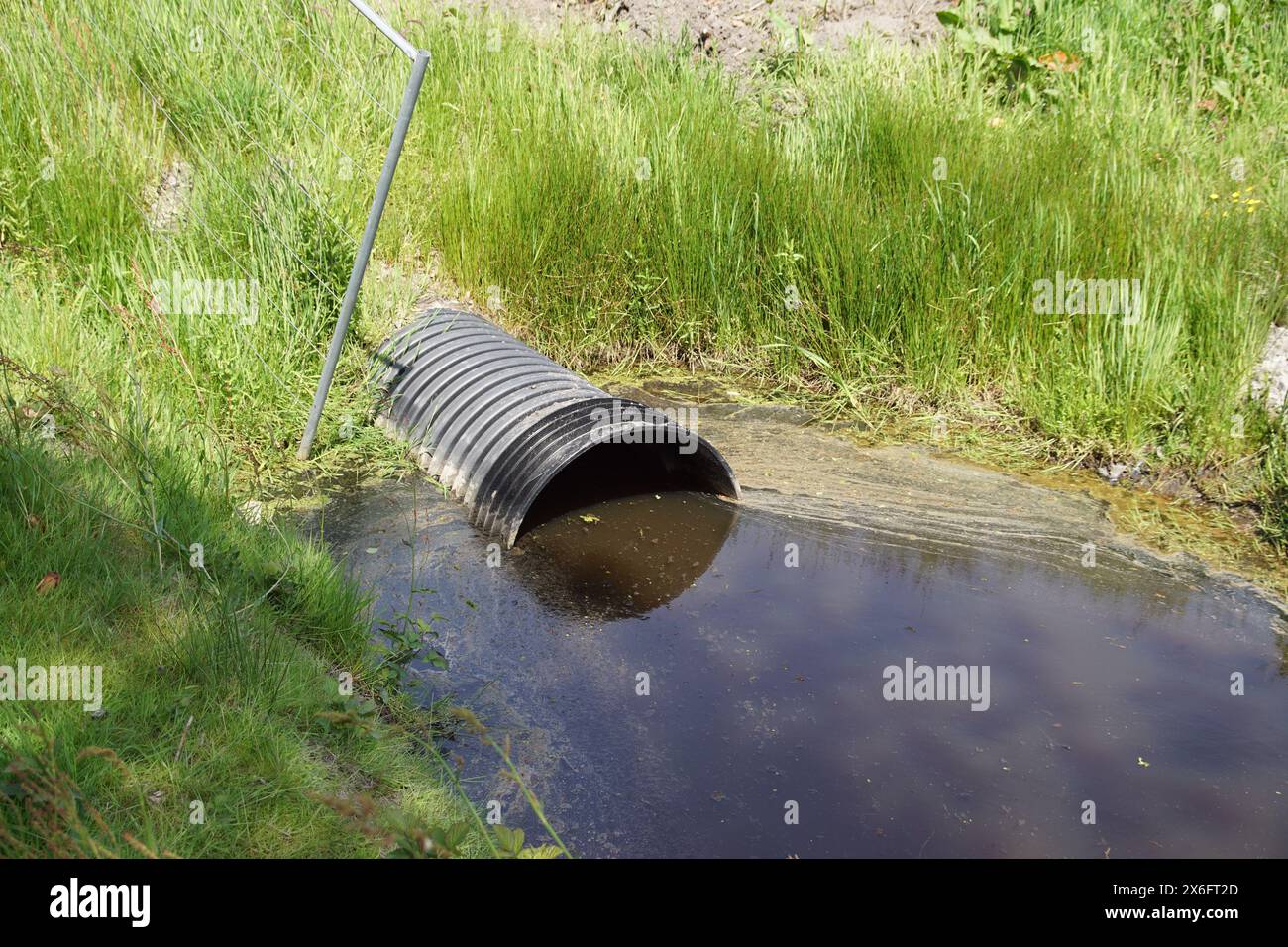 Plastic culvert pipe as a water passage under a dike at a ditch as a ...