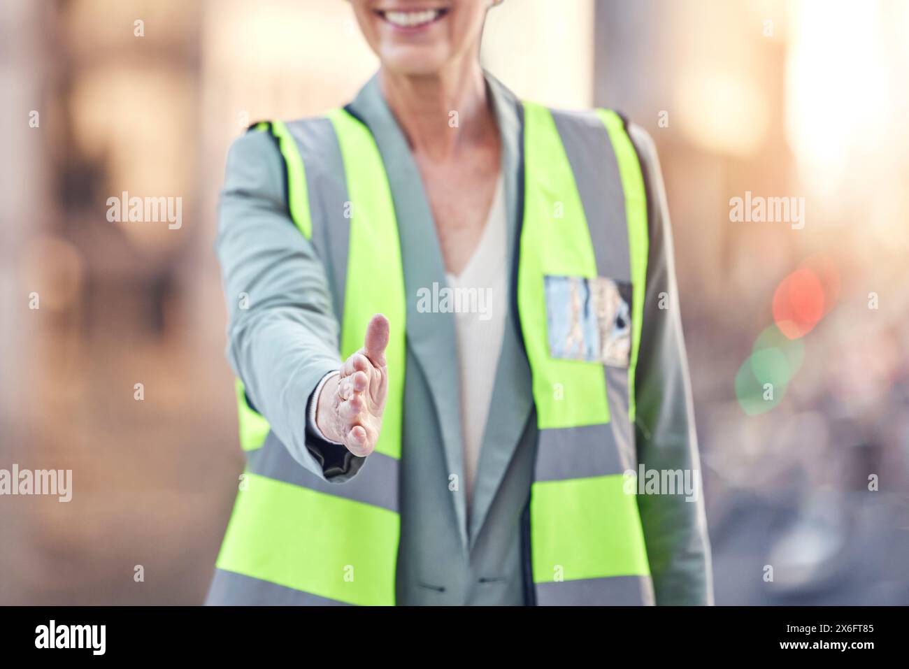 Construction site, handshake and woman in city by buildings with ...