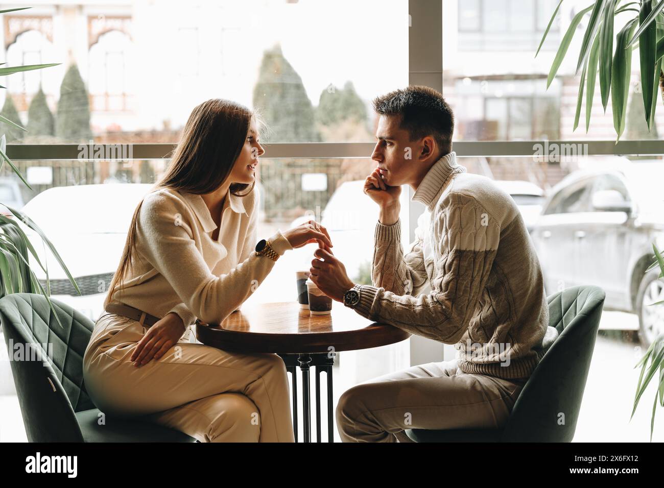 Two Friends Enjoying Casual Conversation Over Coffee at a Modern Cafe ...